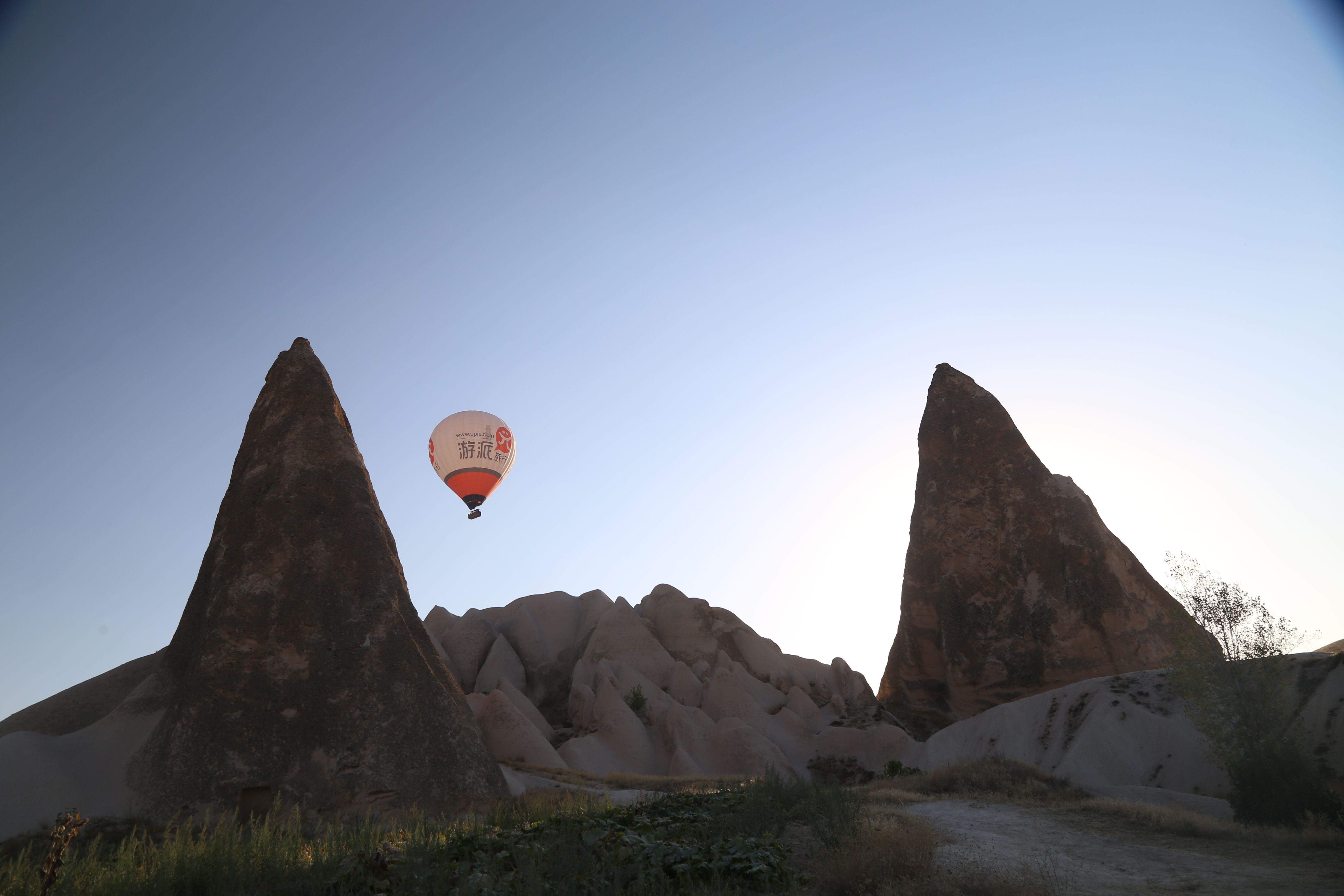 Balloon Flying over Rock Formations · Free Stock Photo