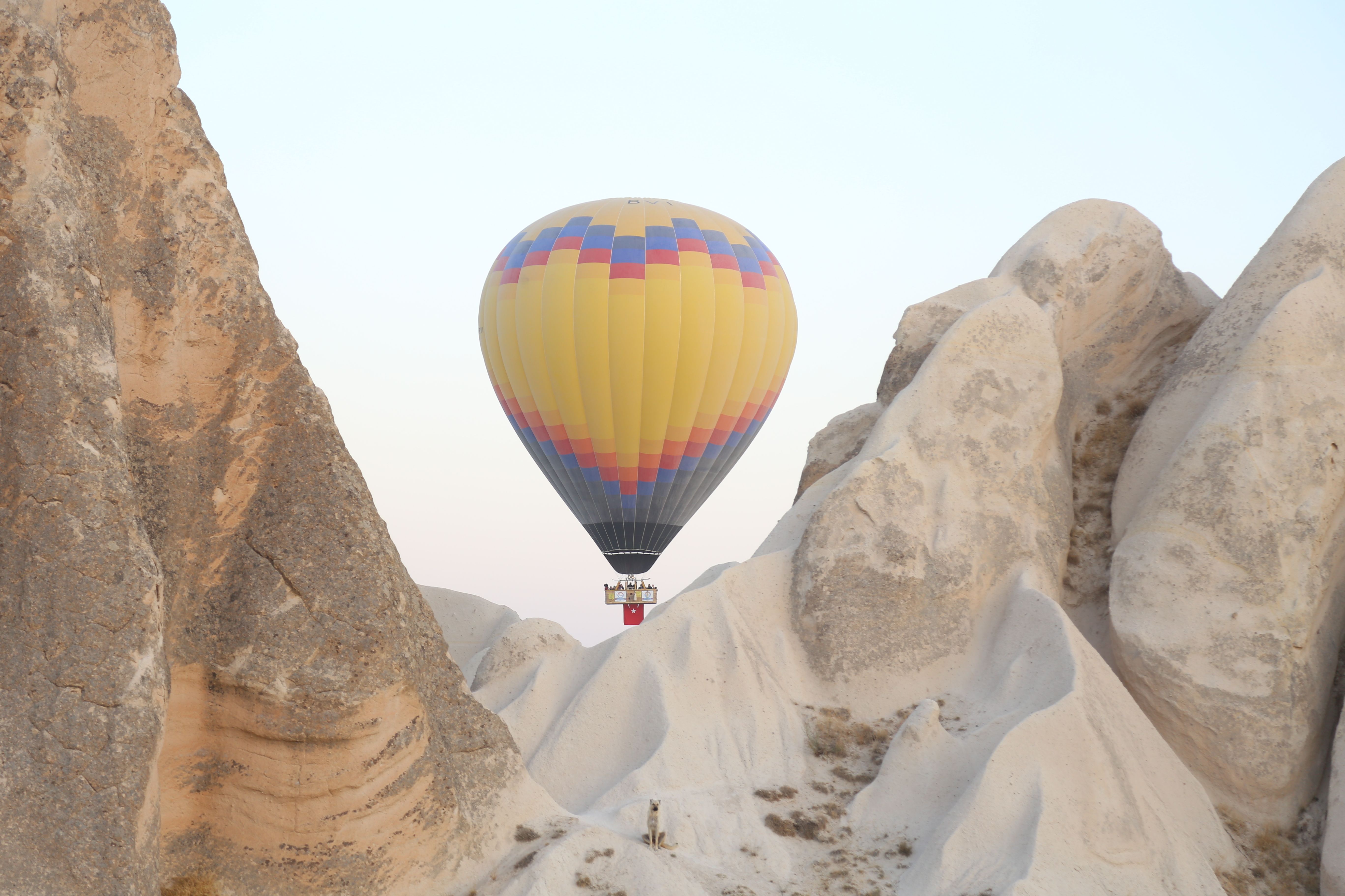 Balloon Flying over Sand and Rock Formations · Free Stock Photo