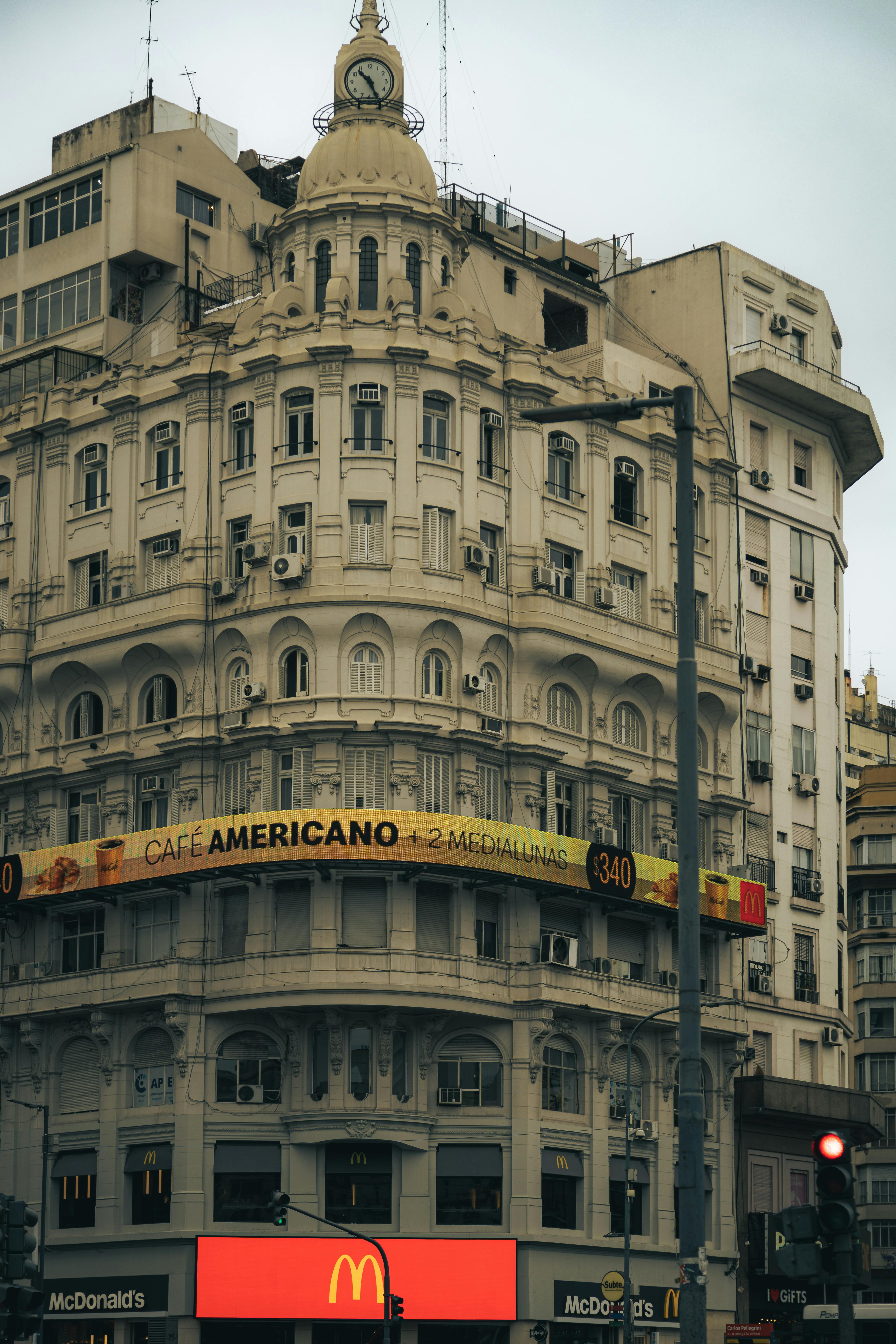 Advertisement on Ornamented Building Wall · Free Stock Photo