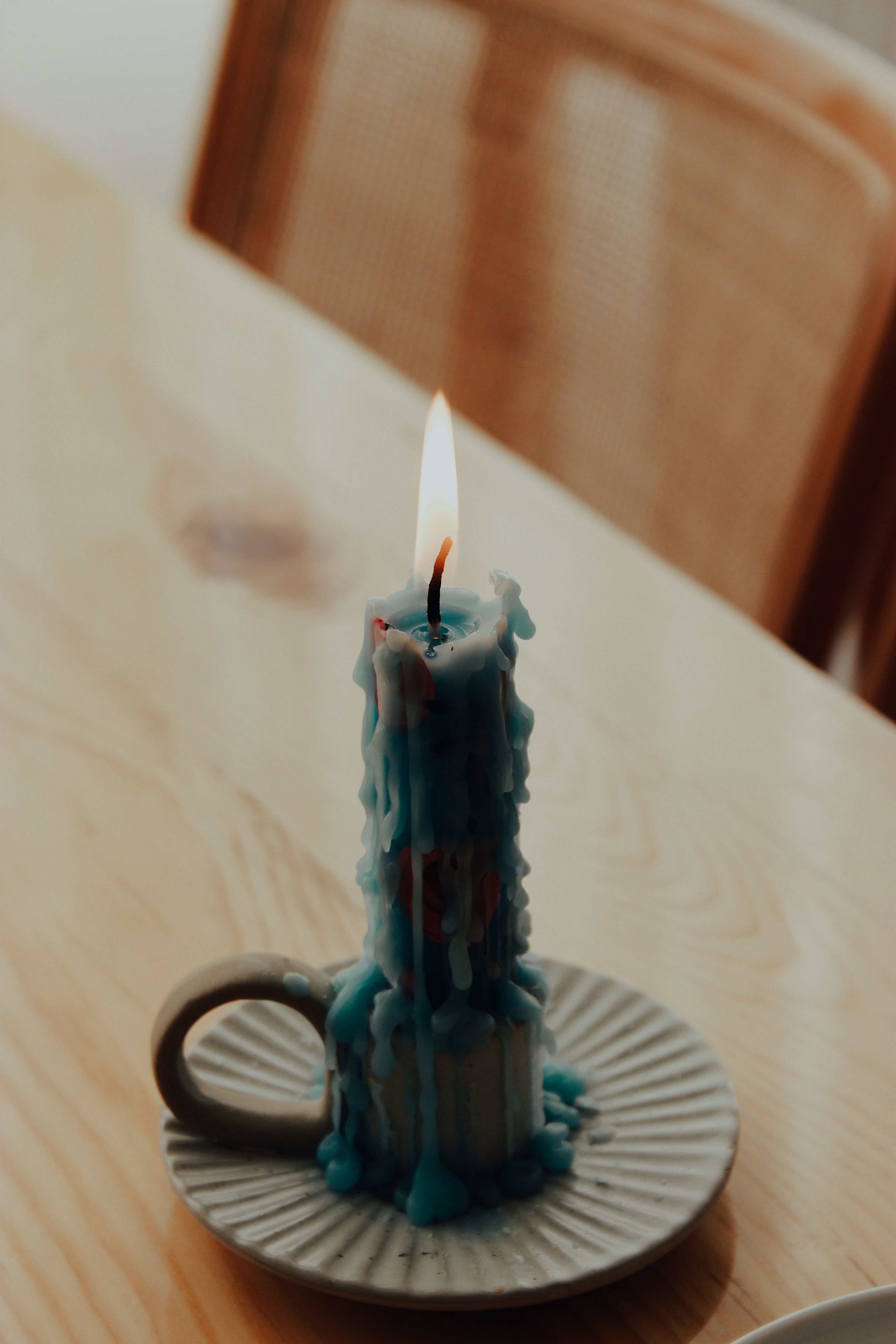 Artistic Blue Wax Candle on Wooden Table · Free Stock Photo