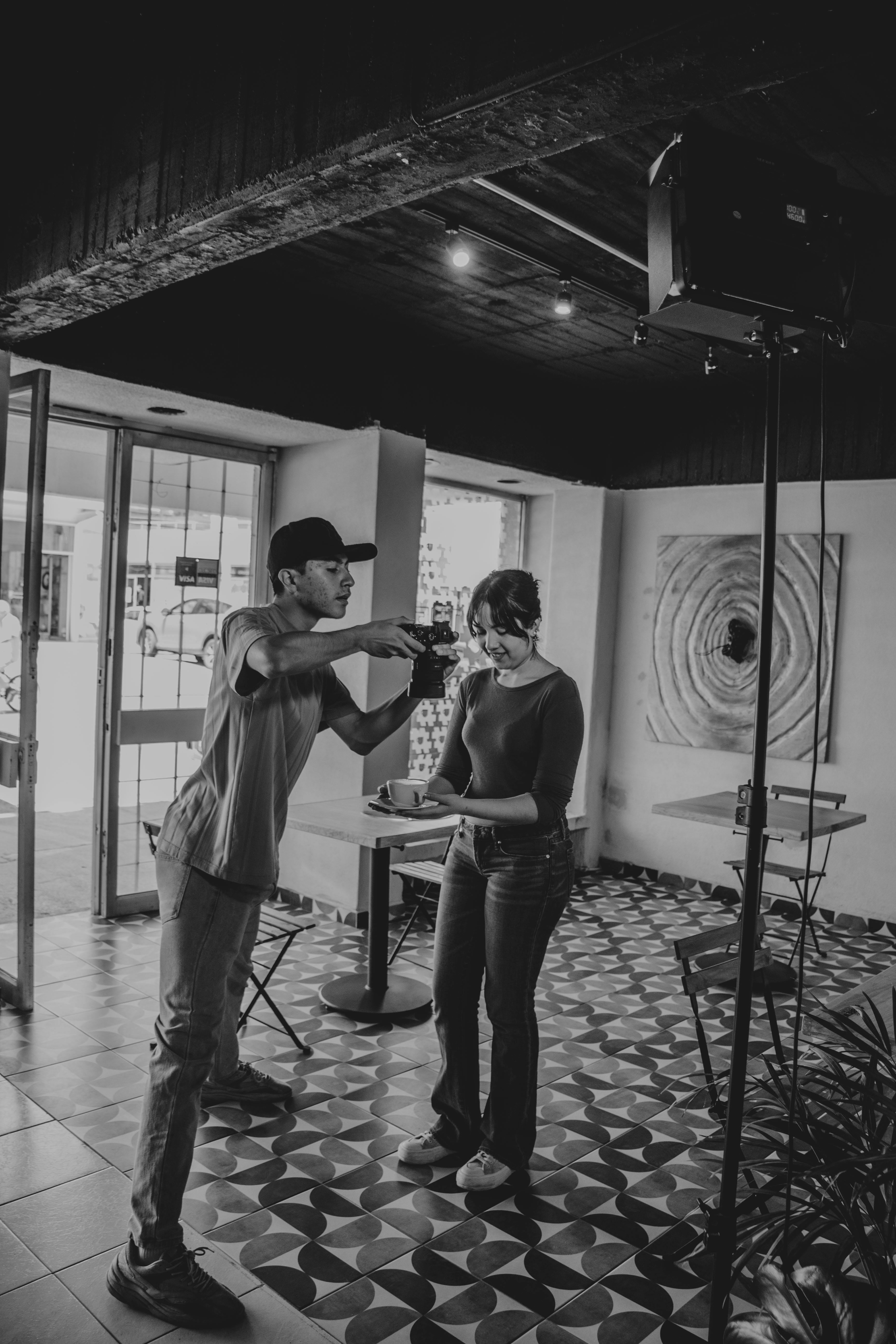 Photographer Taking Photos of Coffee in Cup on Table in Cafe · Free ...