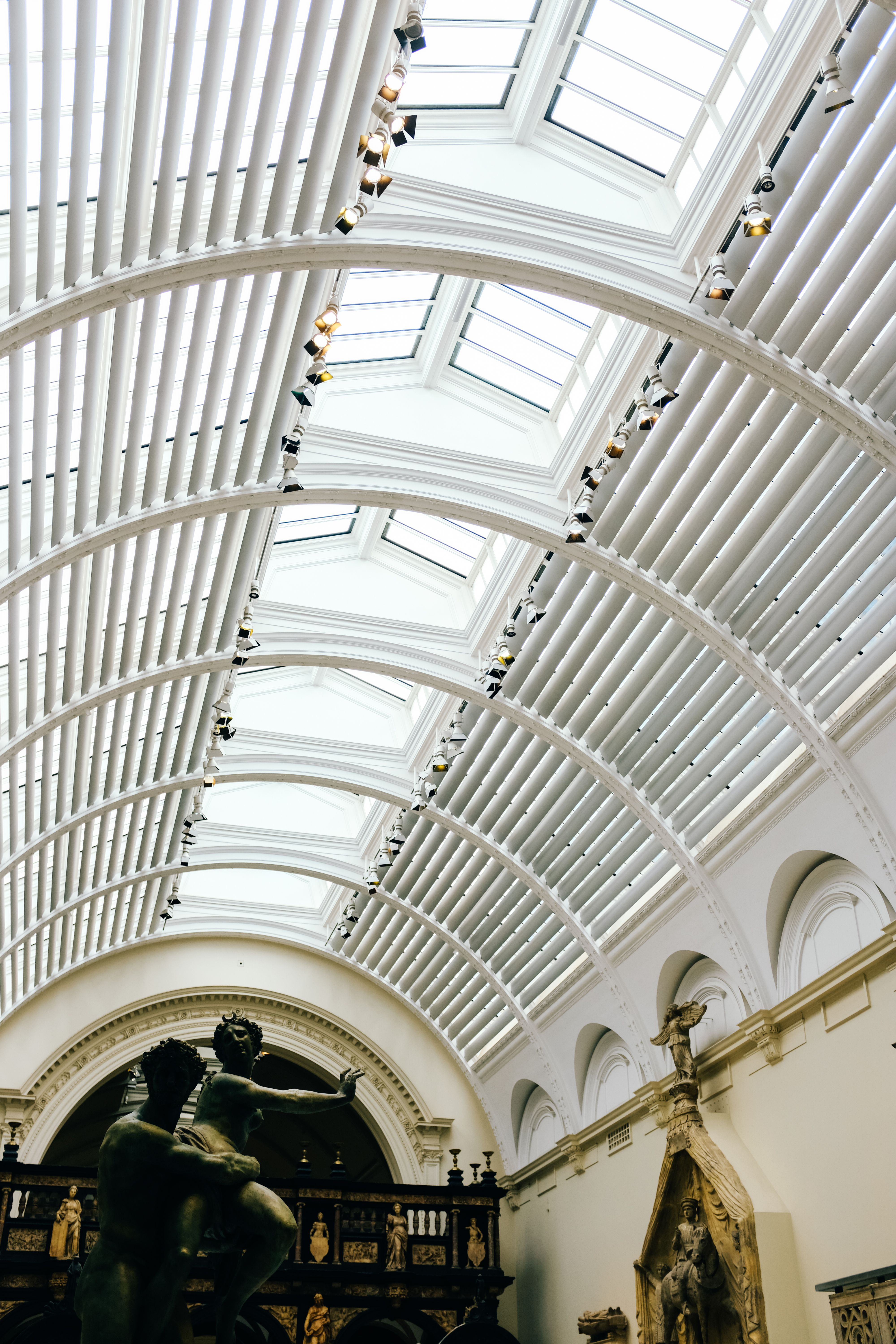 Elegant Museum Interior with Sculptures and Skylight · Free Stock Photo