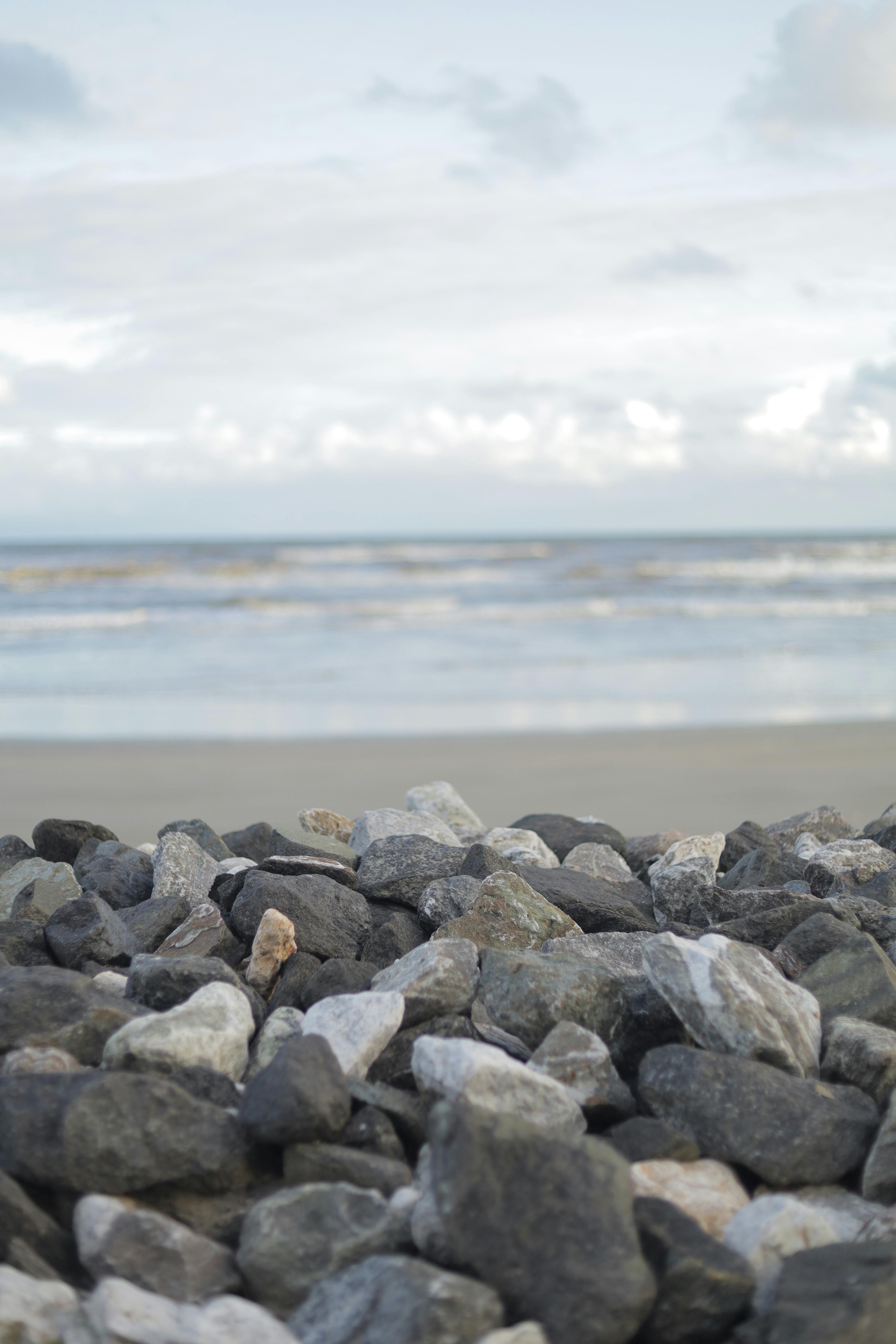Pebbles on Beach Shore During Sunset · Free Stock Photo