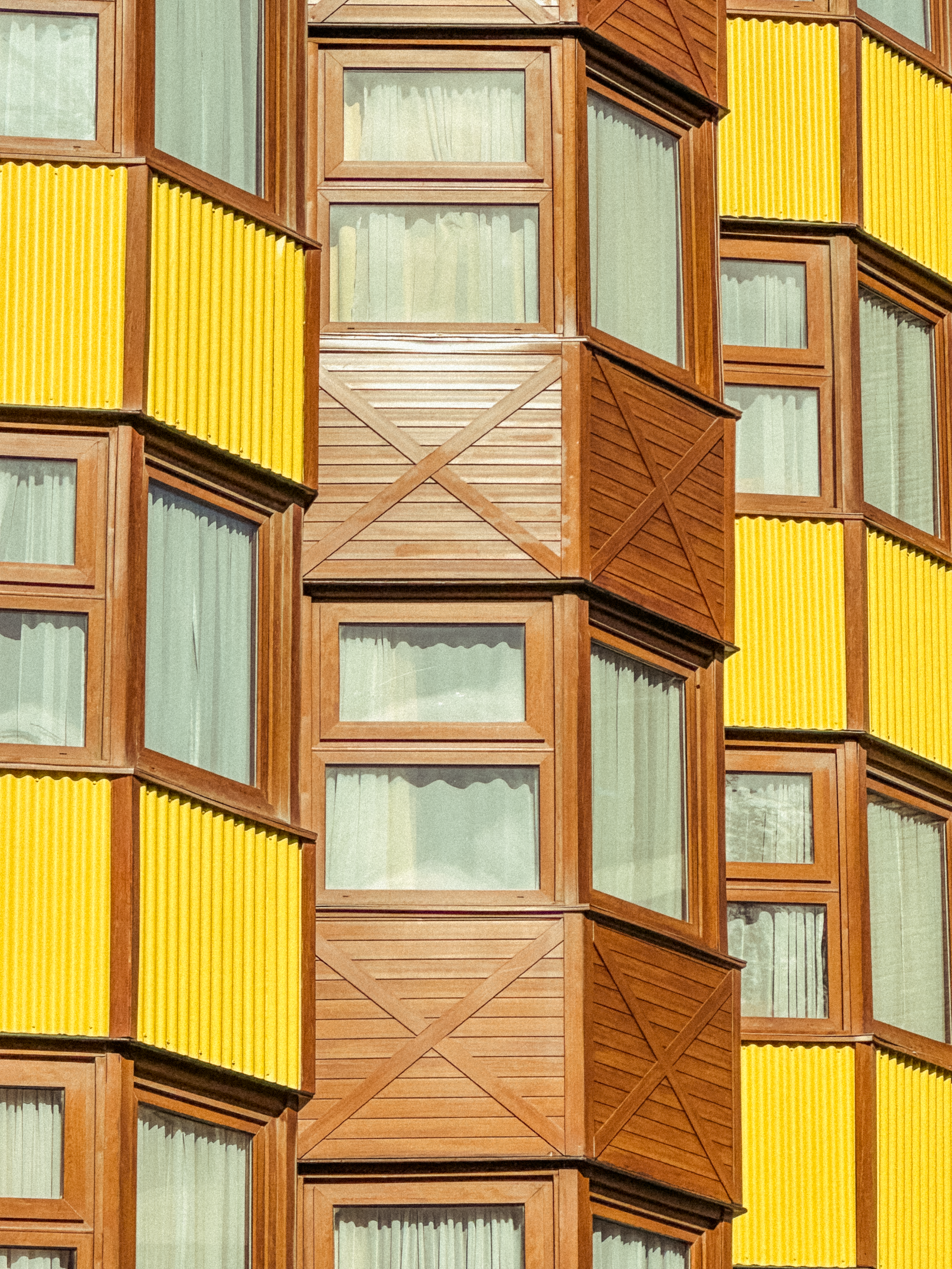 Red Lights on the Windows of an Apartment Building · Free Stock Photo