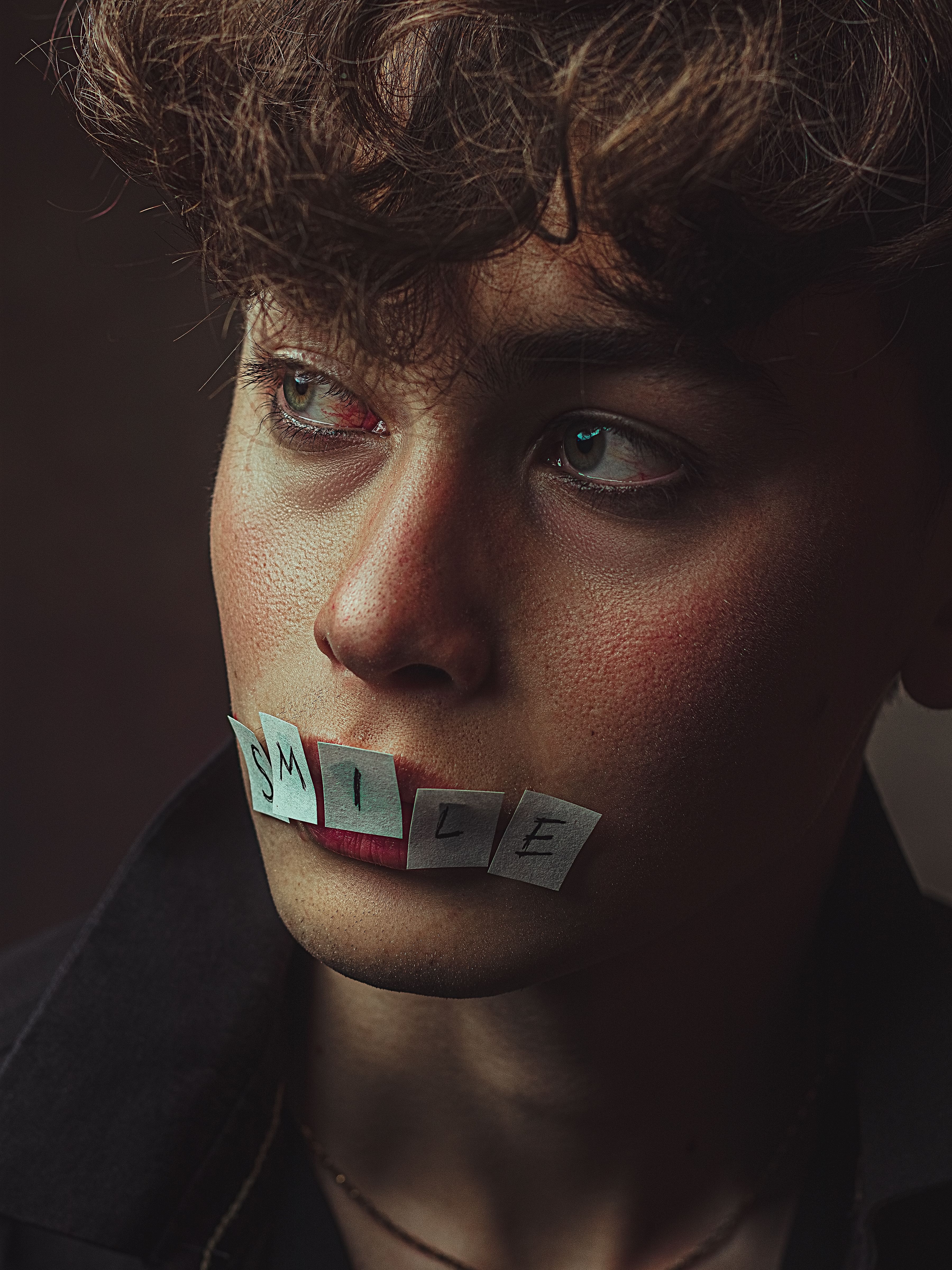 Person with Written Letters Sticking on Mouth · Free Stock Photo