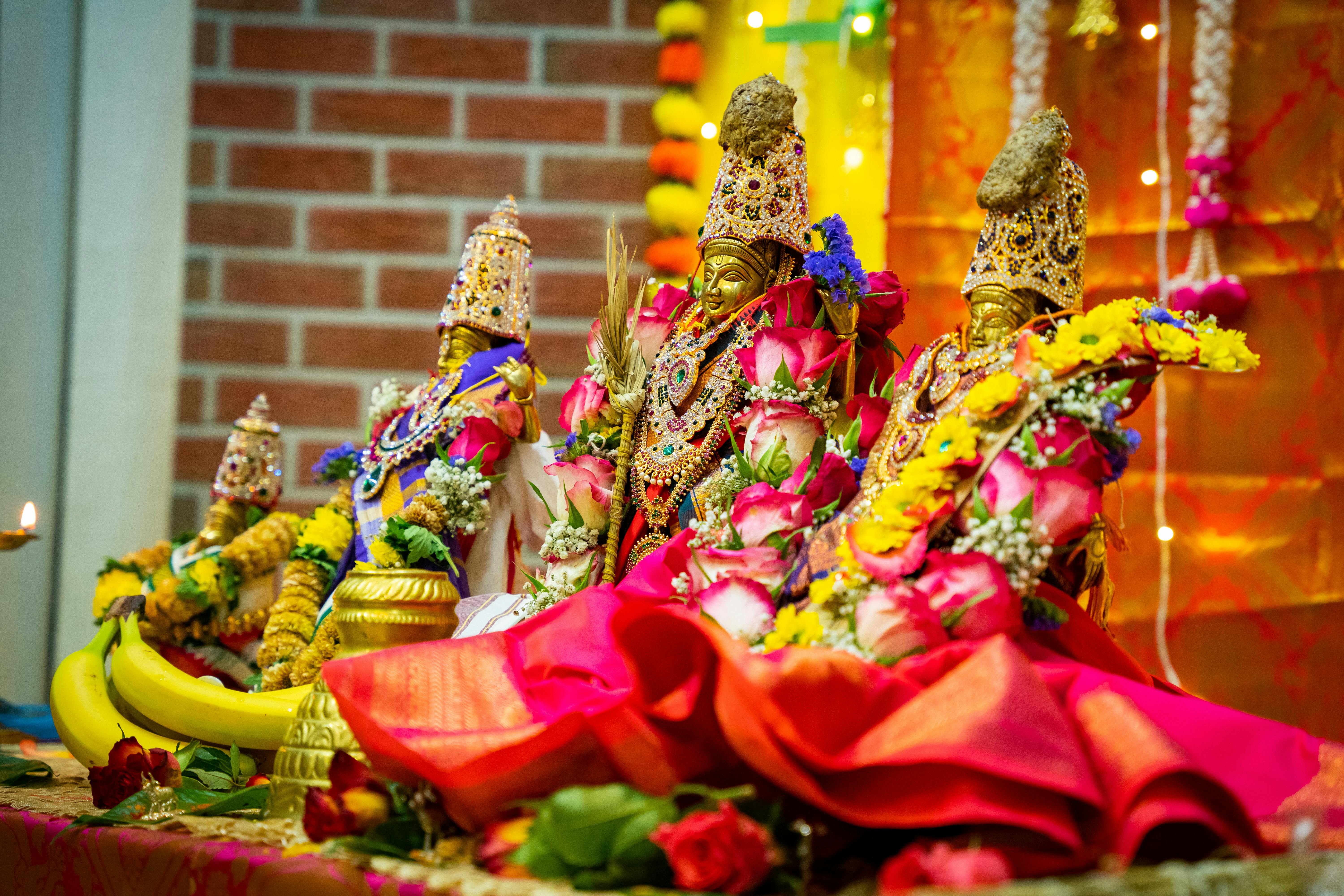 Hindu Deities Figurines Decorated with Colorful Flowers · Free Stock Photo