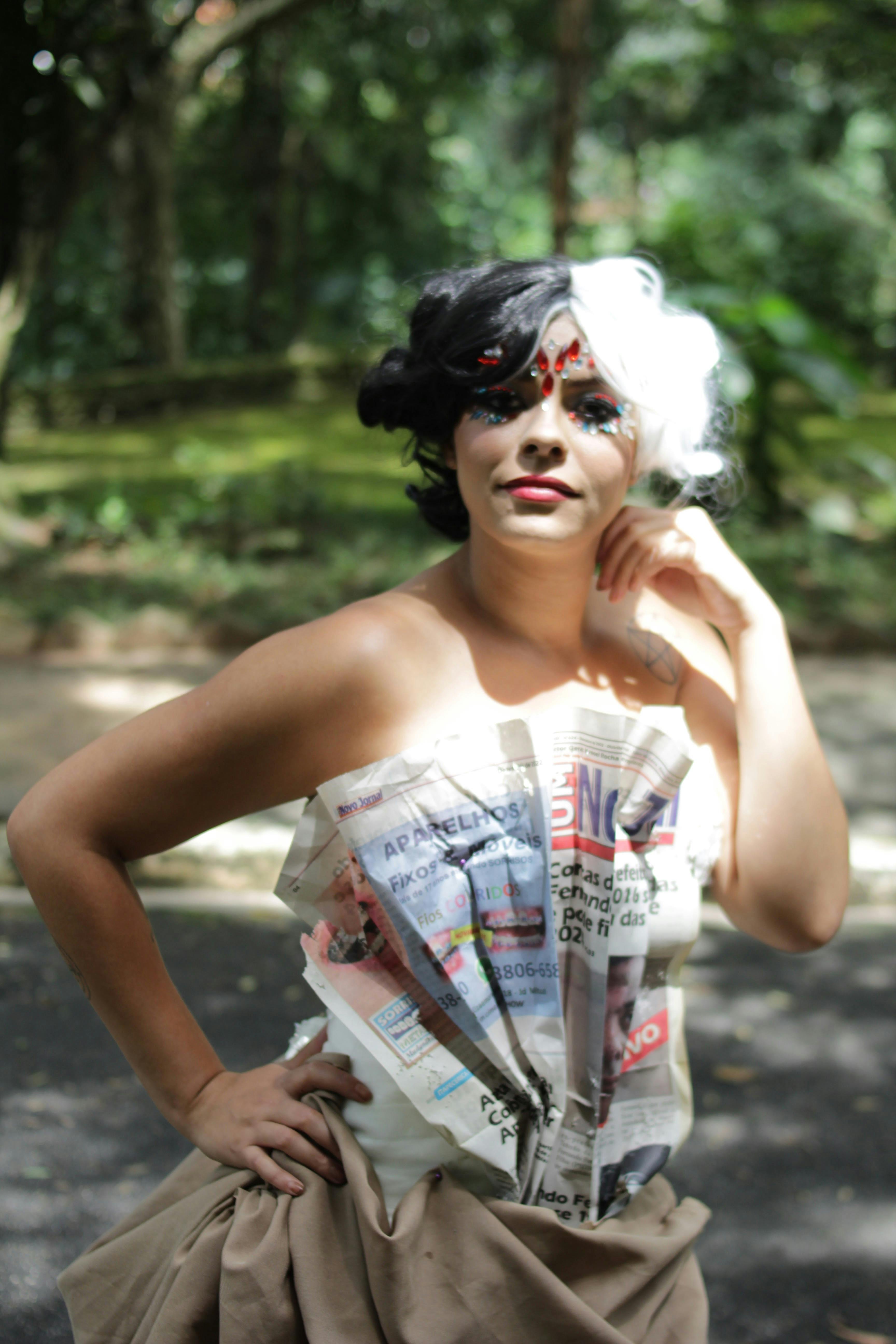 Woman Wearing Newspaper Dress Sitting on Sofa · Free Stock Photo