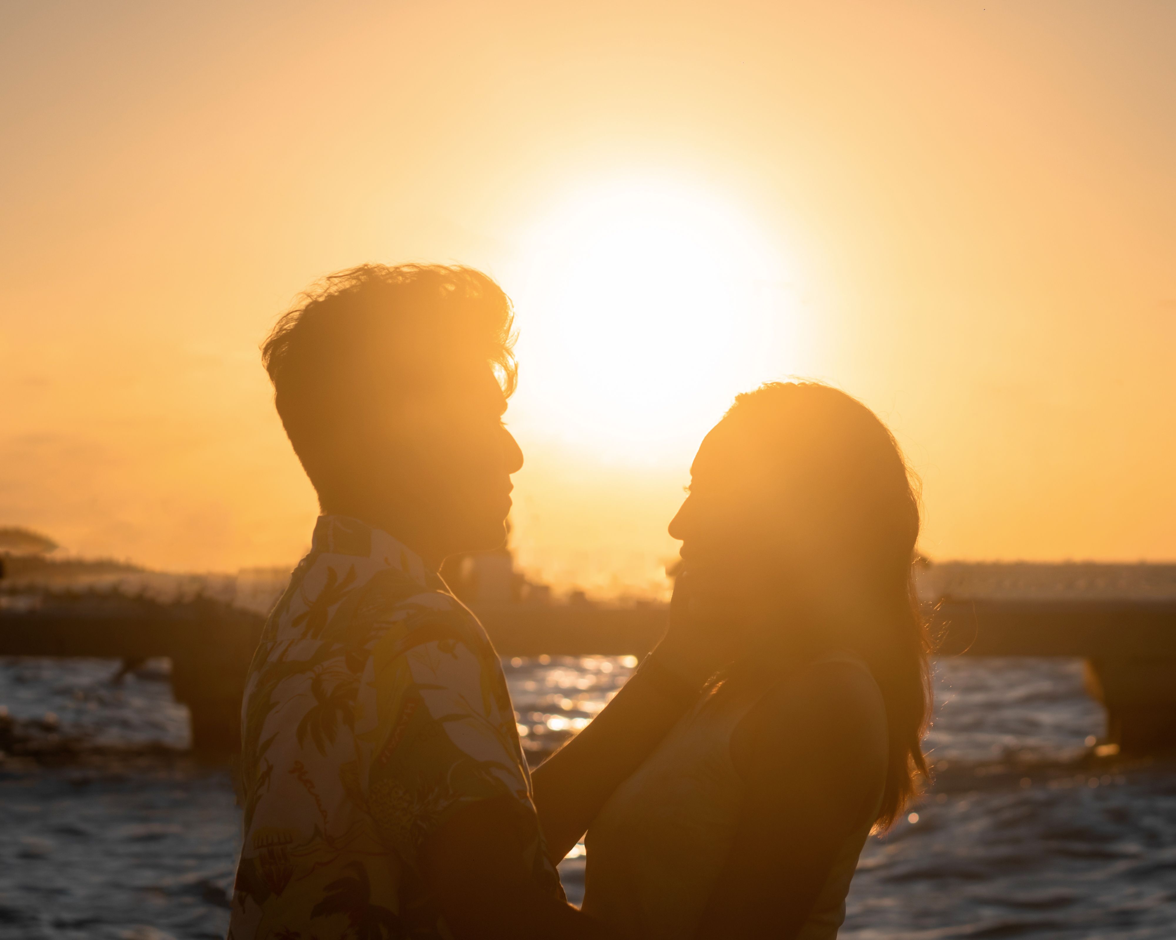 Sunset Sunlight over Couple on Sea Shore · Free Stock Photo