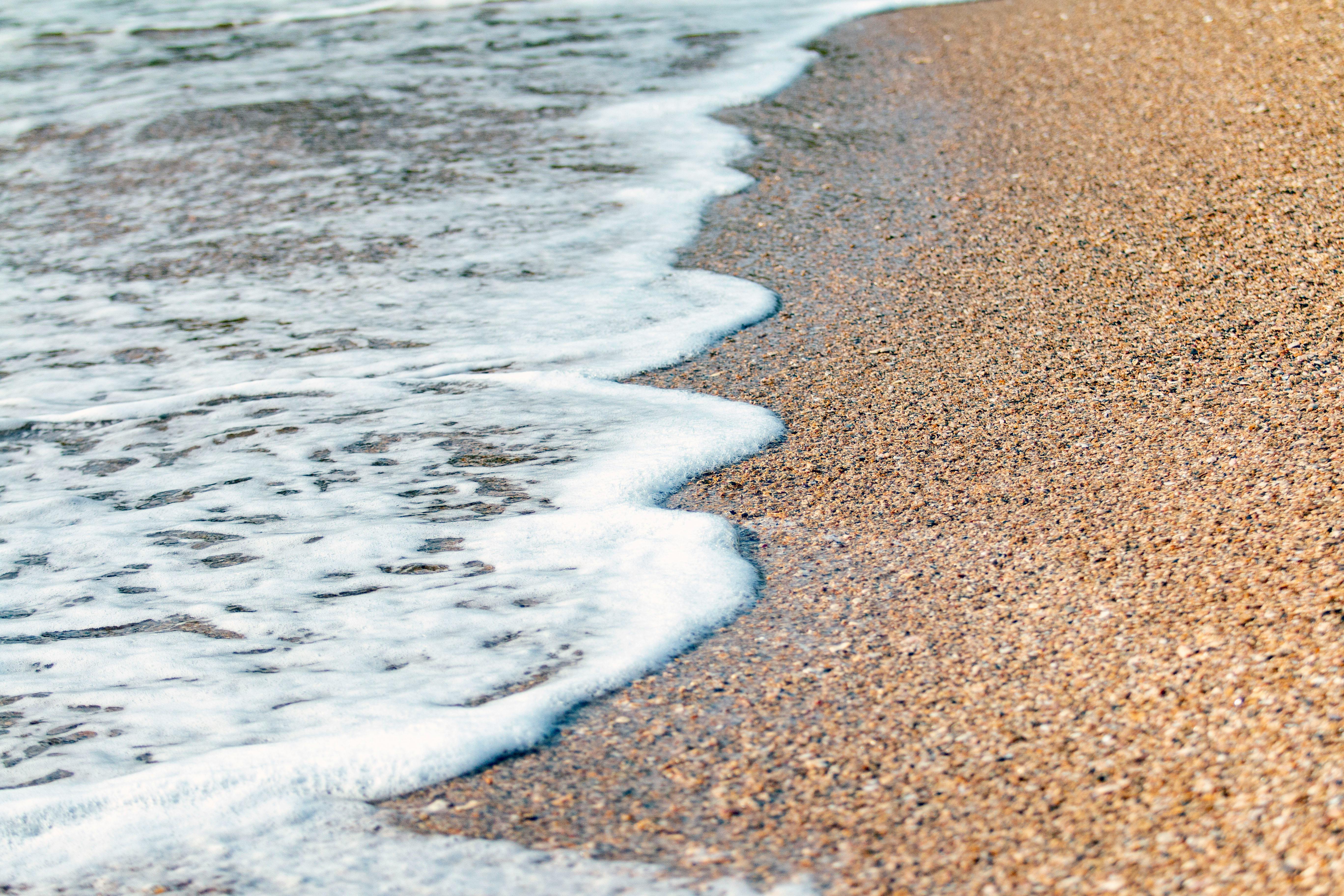 Close-up of Foamy Waves Washing up the Beach · Free Stock Photo