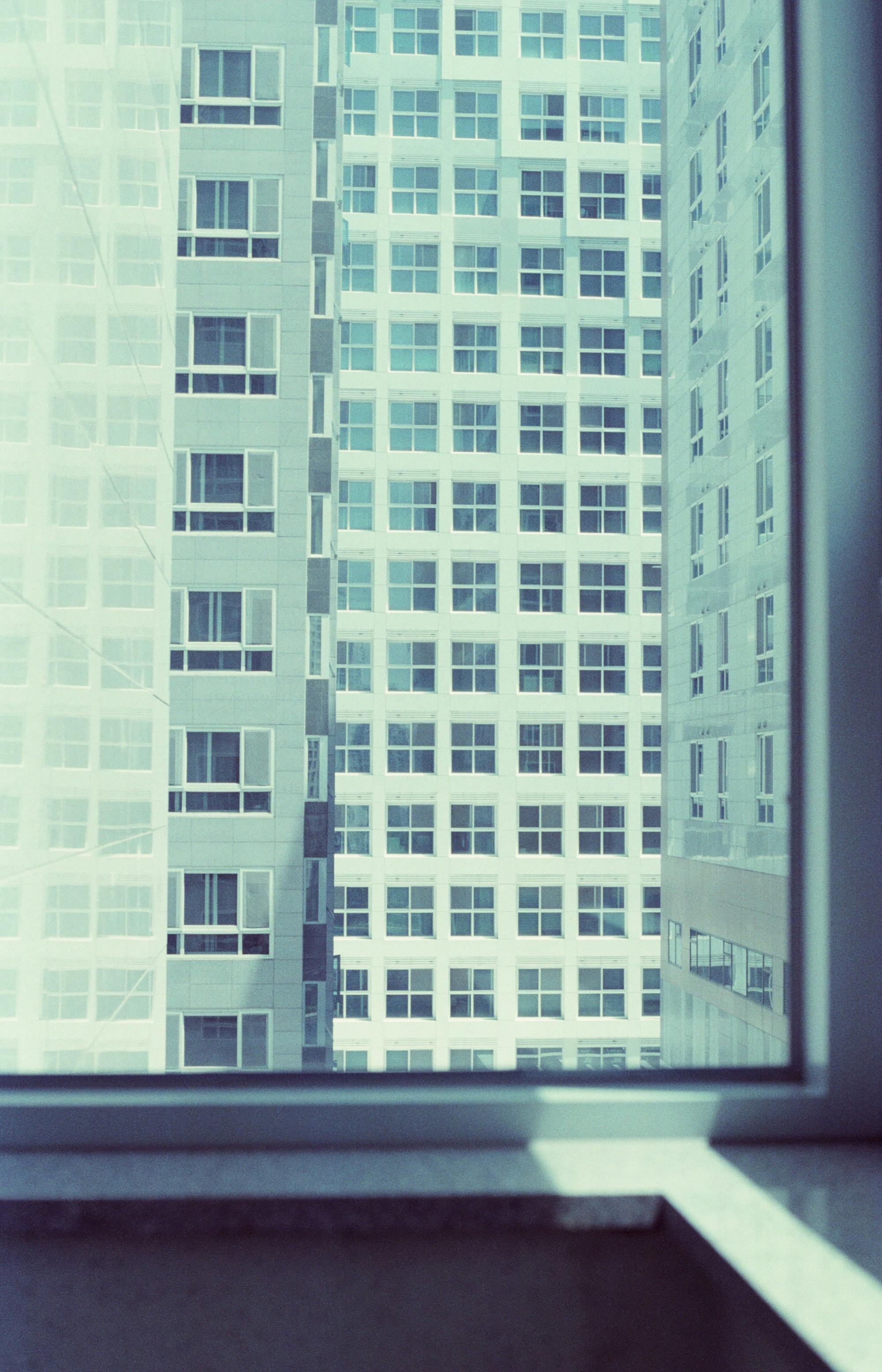 Residential Skyscraper behind Window · Free Stock Photo