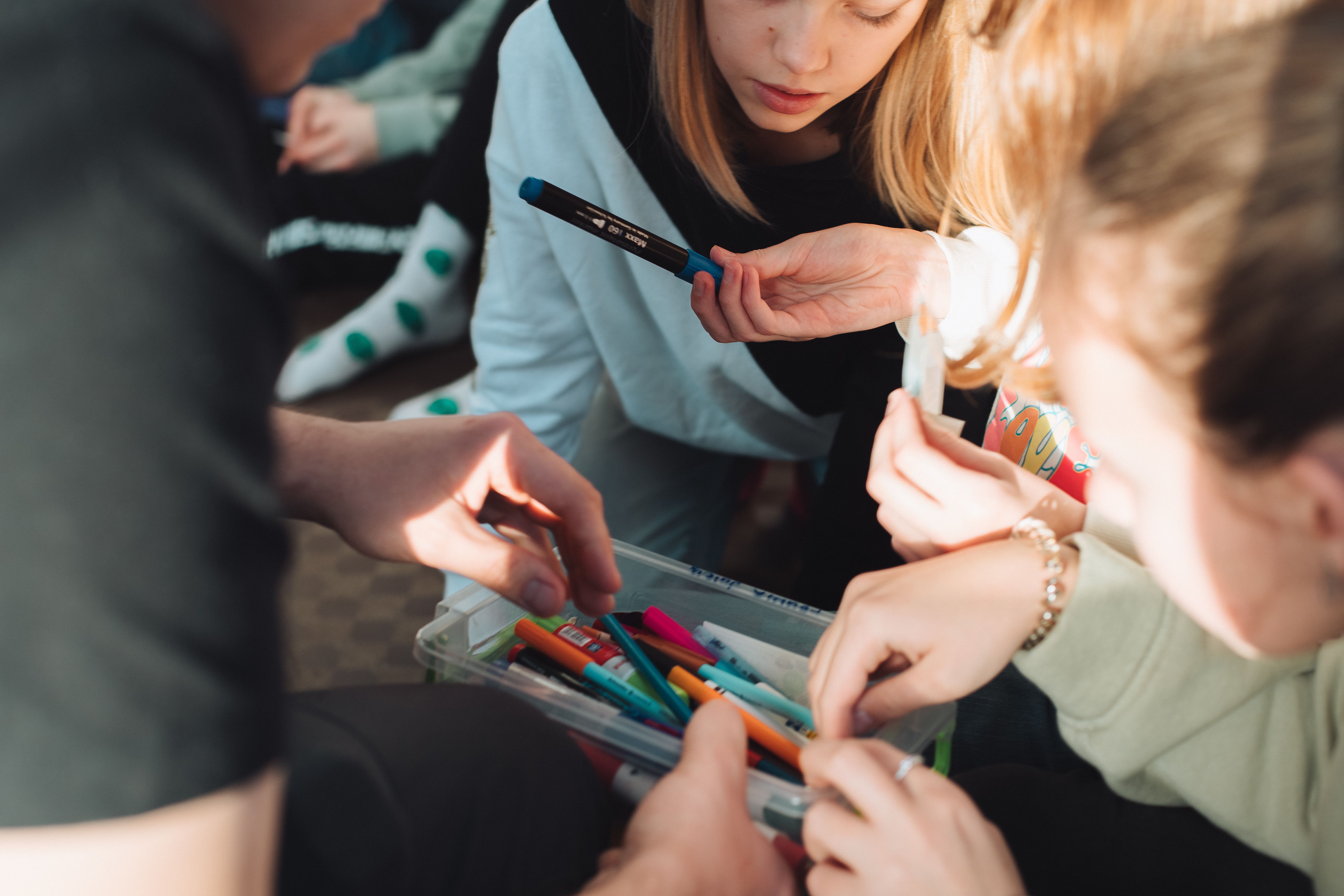 Friends Holding Pens · Free Stock Photo