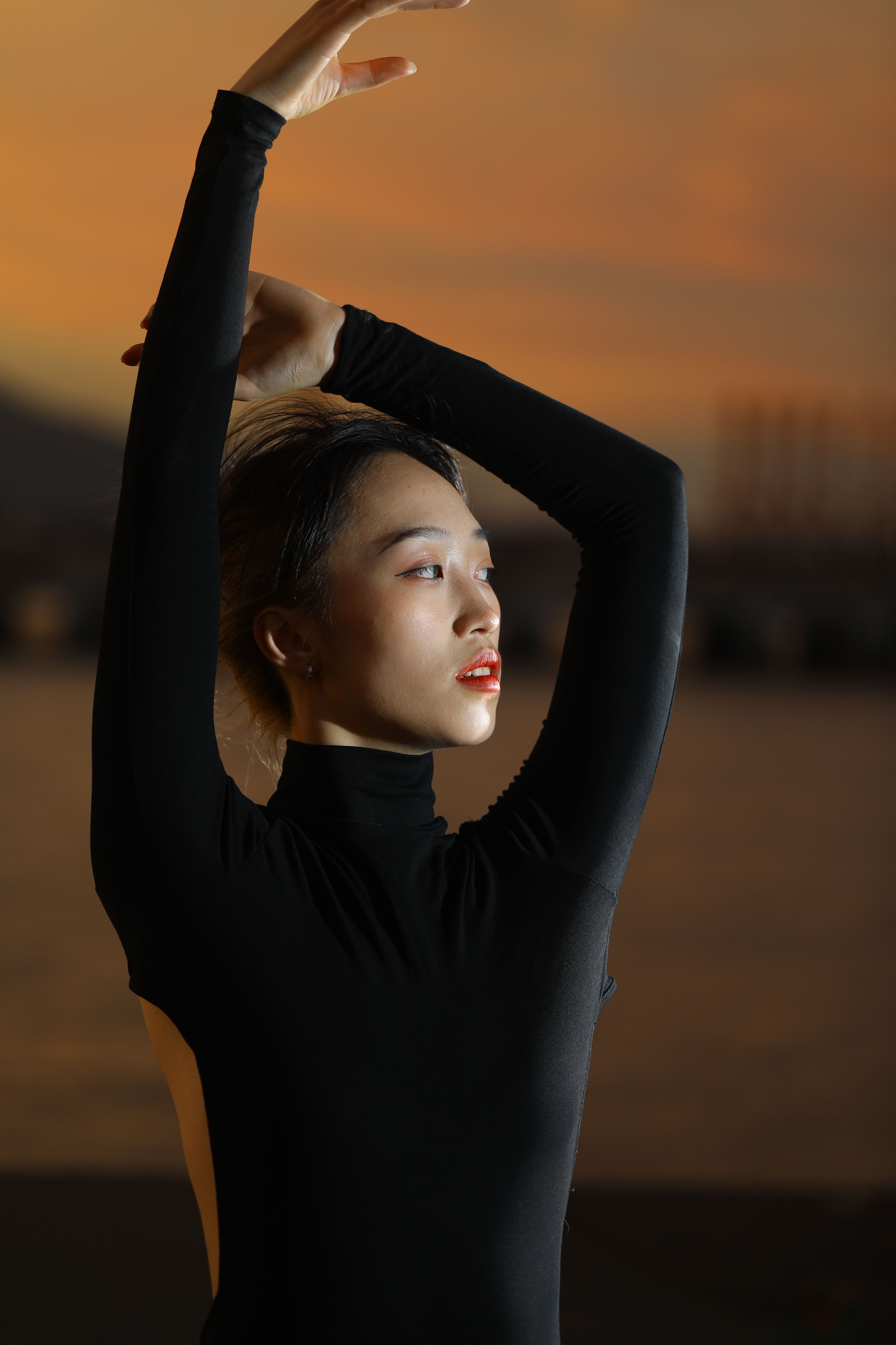 Woman Posing with Arms Raised · Free Stock Photo
