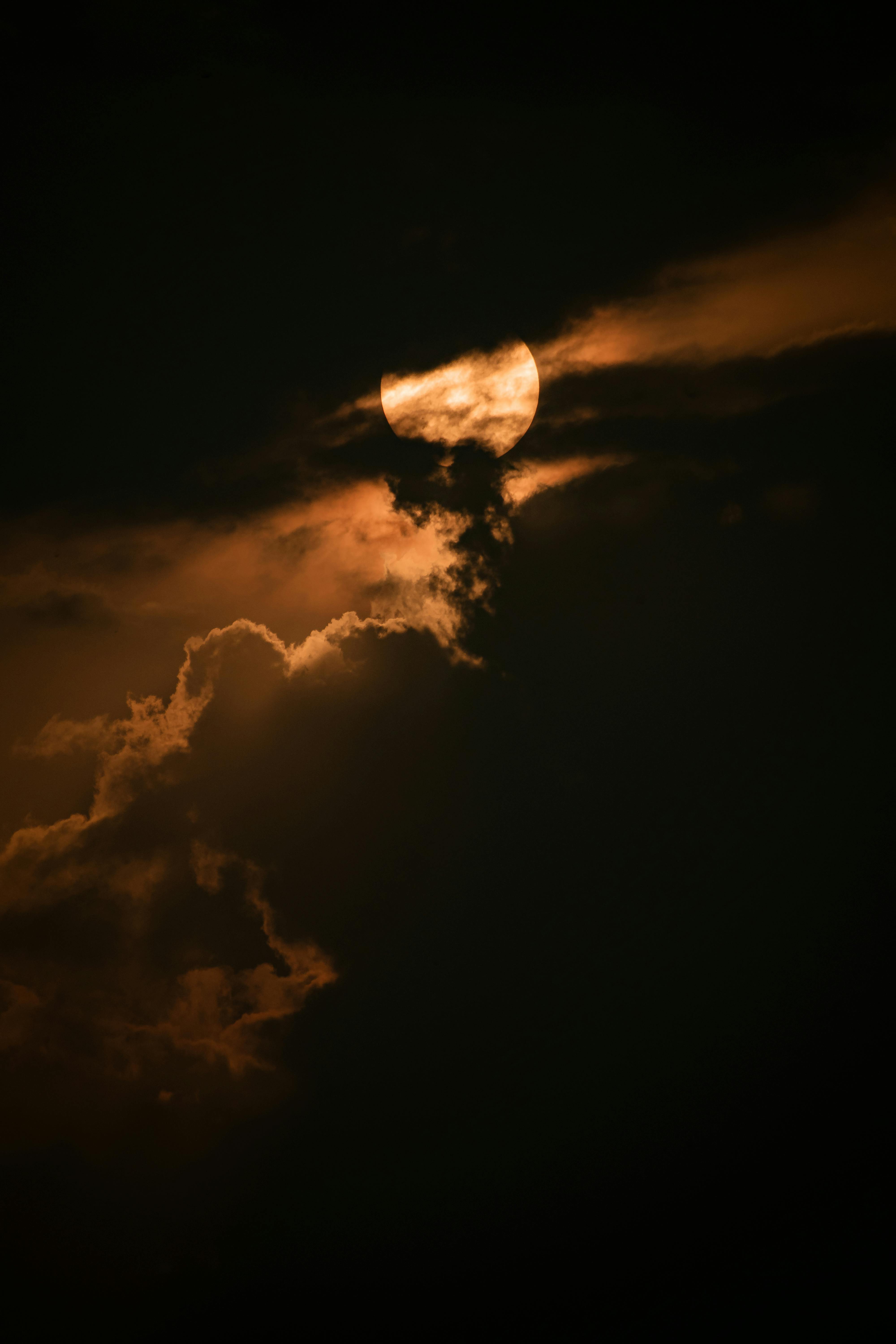 Moon behind Clouds on Sky at Sunset · Free Stock Photo