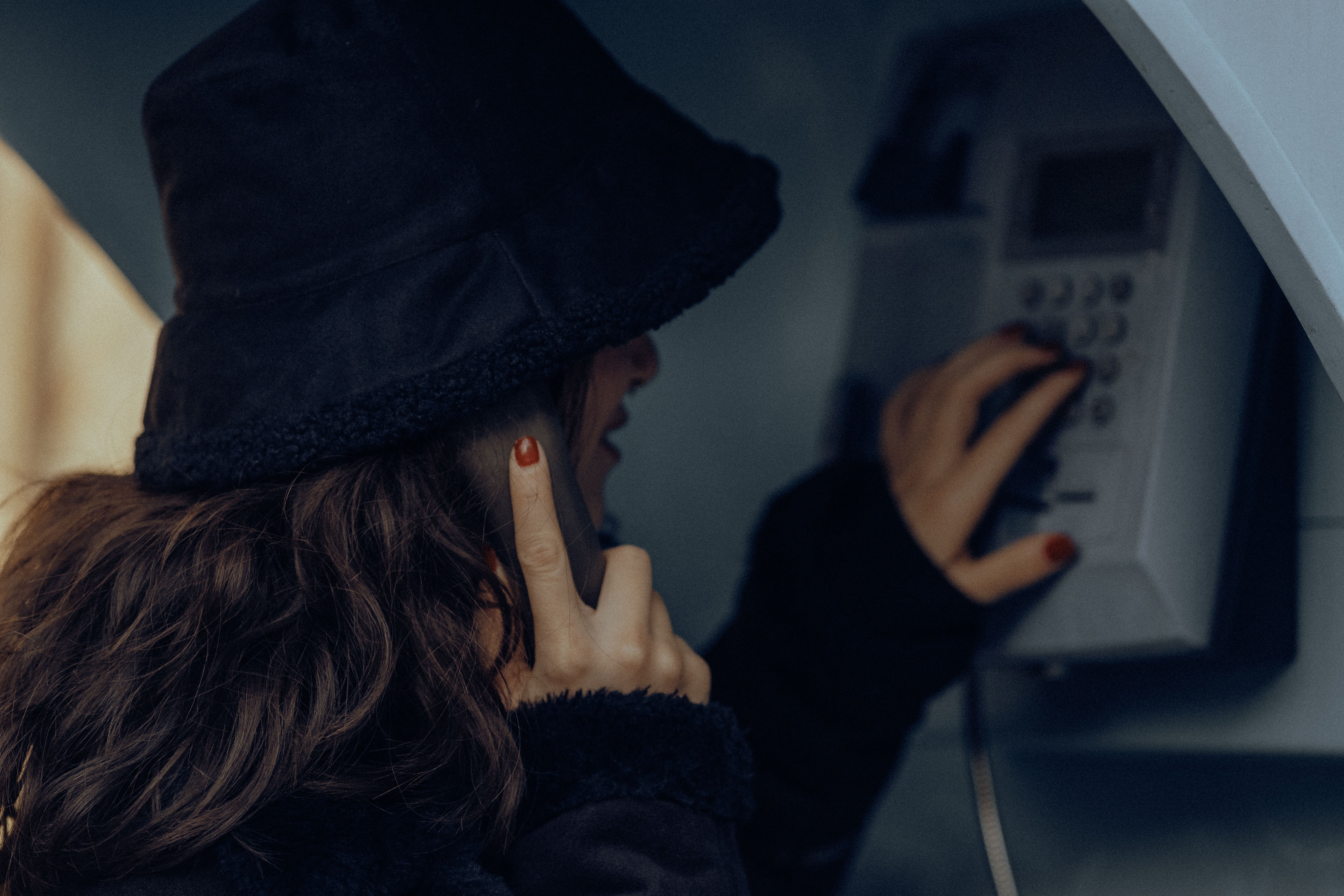 Woman Using Public Telephone · Free Stock Photo