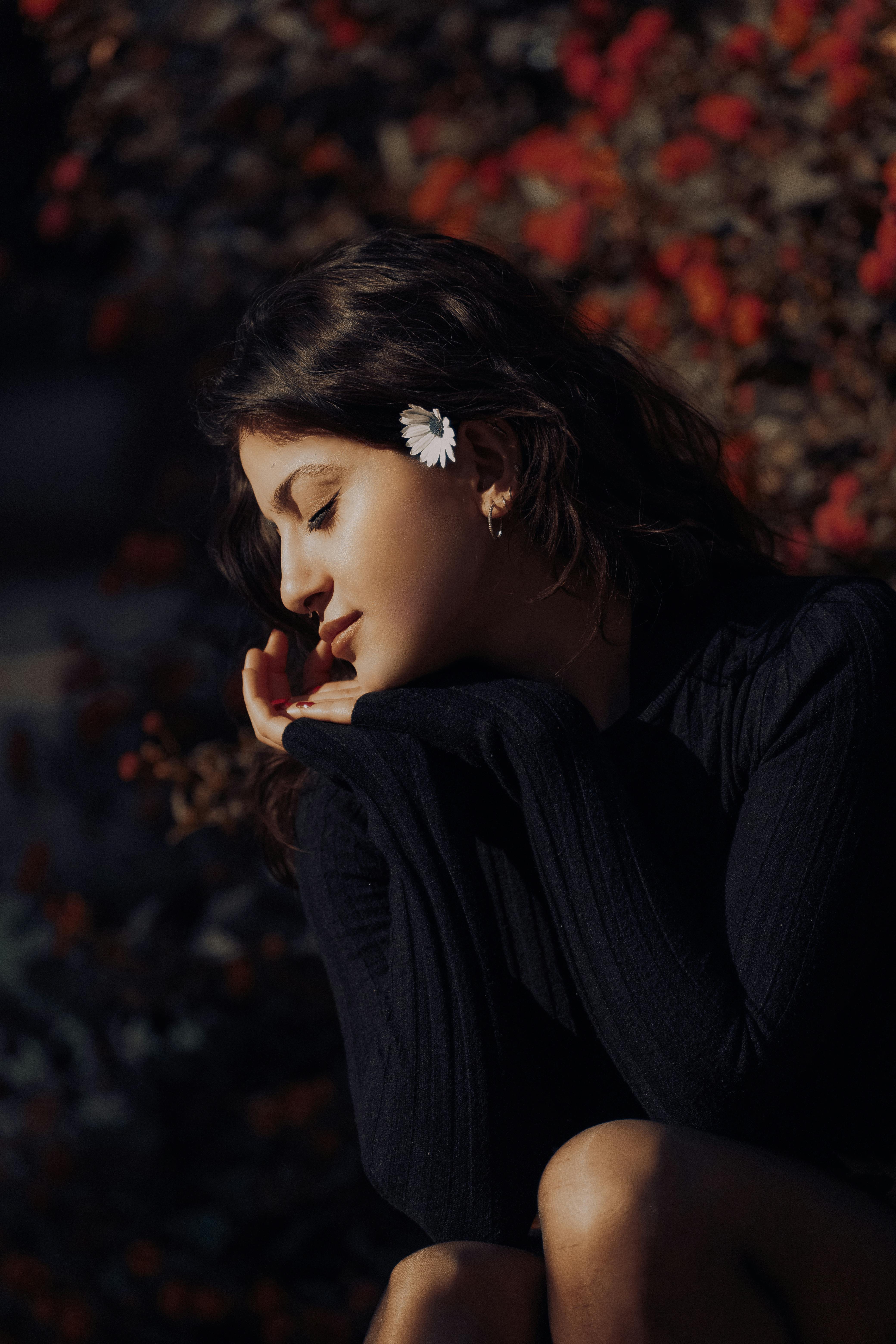 Sunlit Face of Brunette Woman with Flower in Hair · Free Stock Photo
