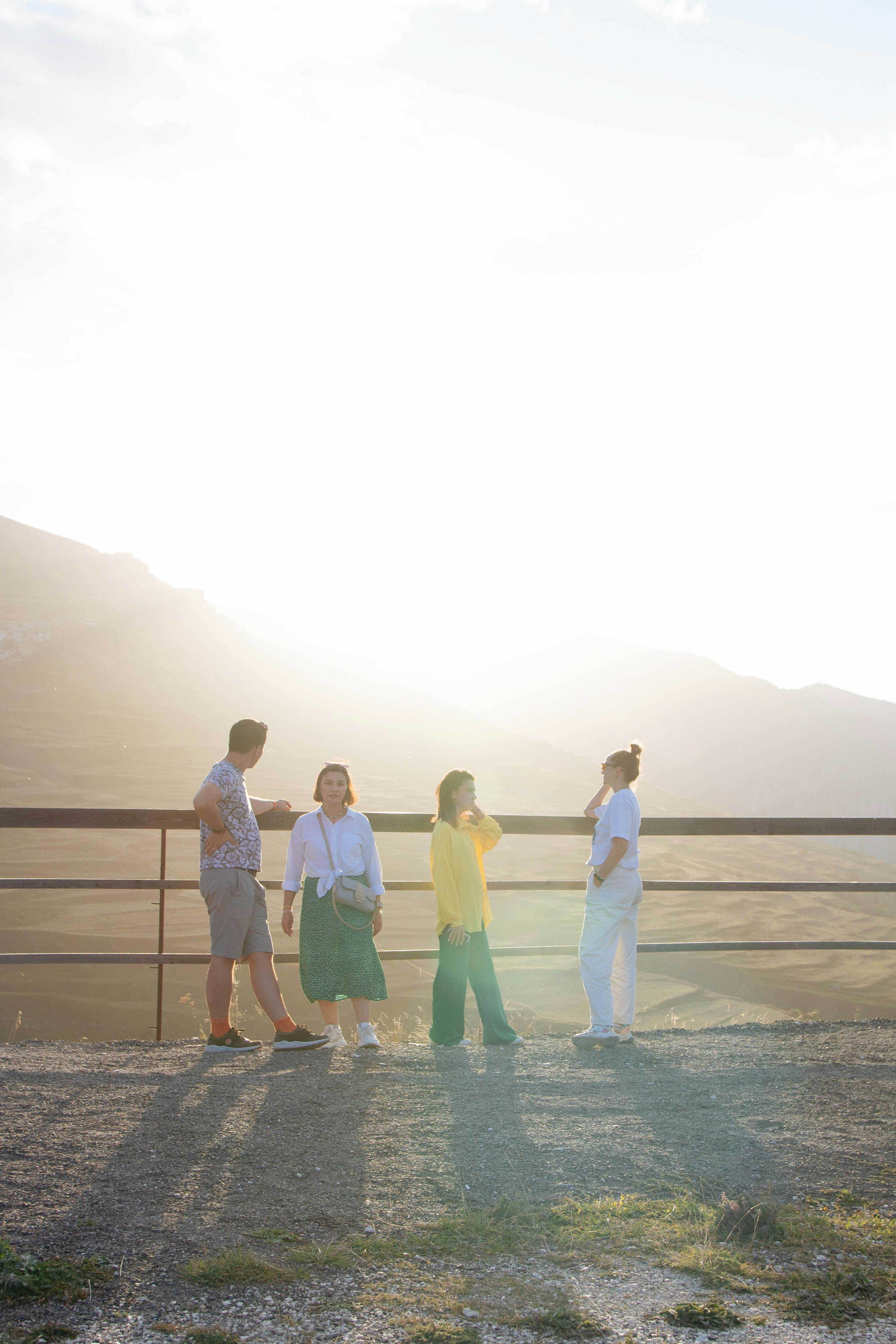 People Standing by a Railing · Free Stock Photo