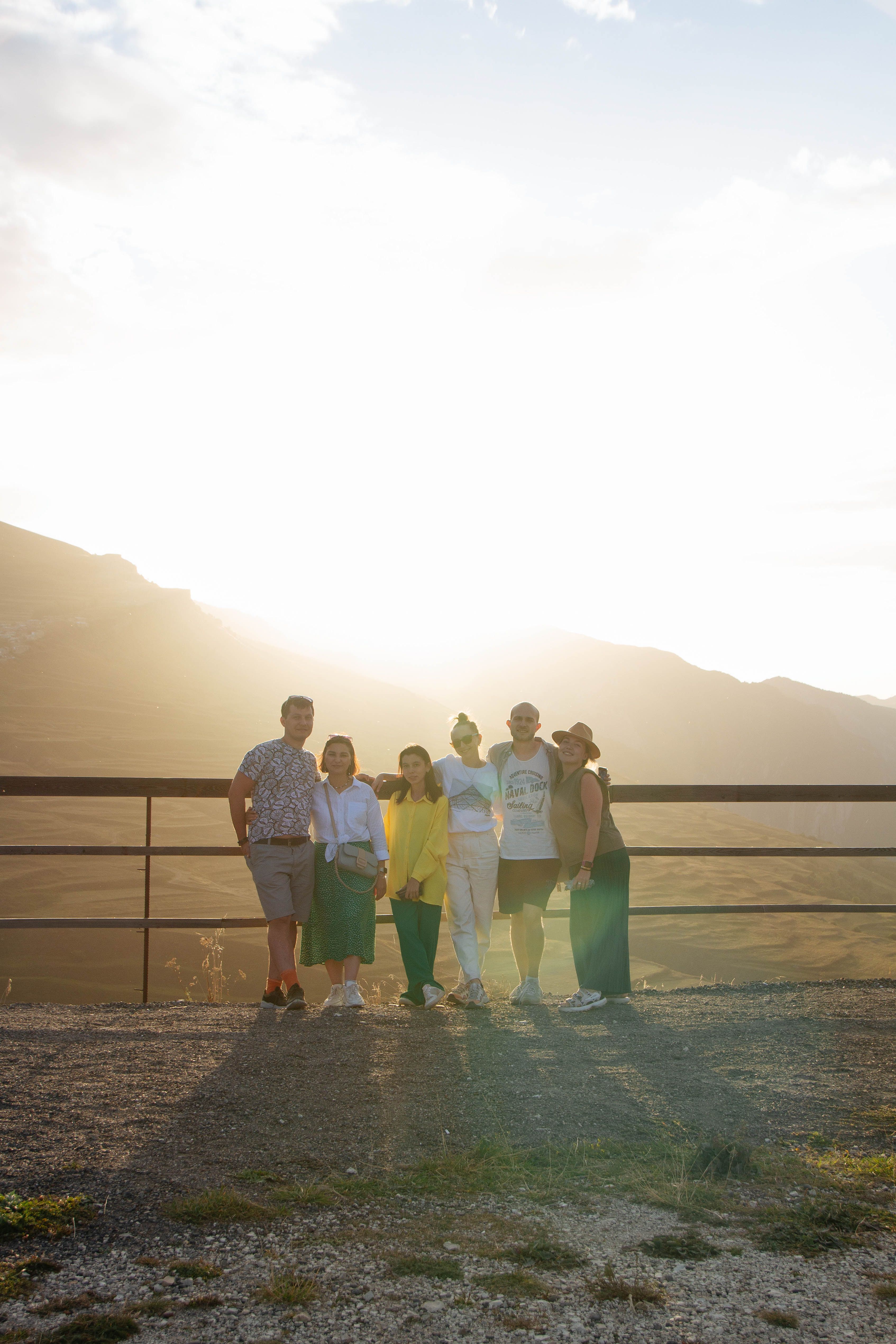 A Group of People Standing Together at Sunset · Free Stock Photo
