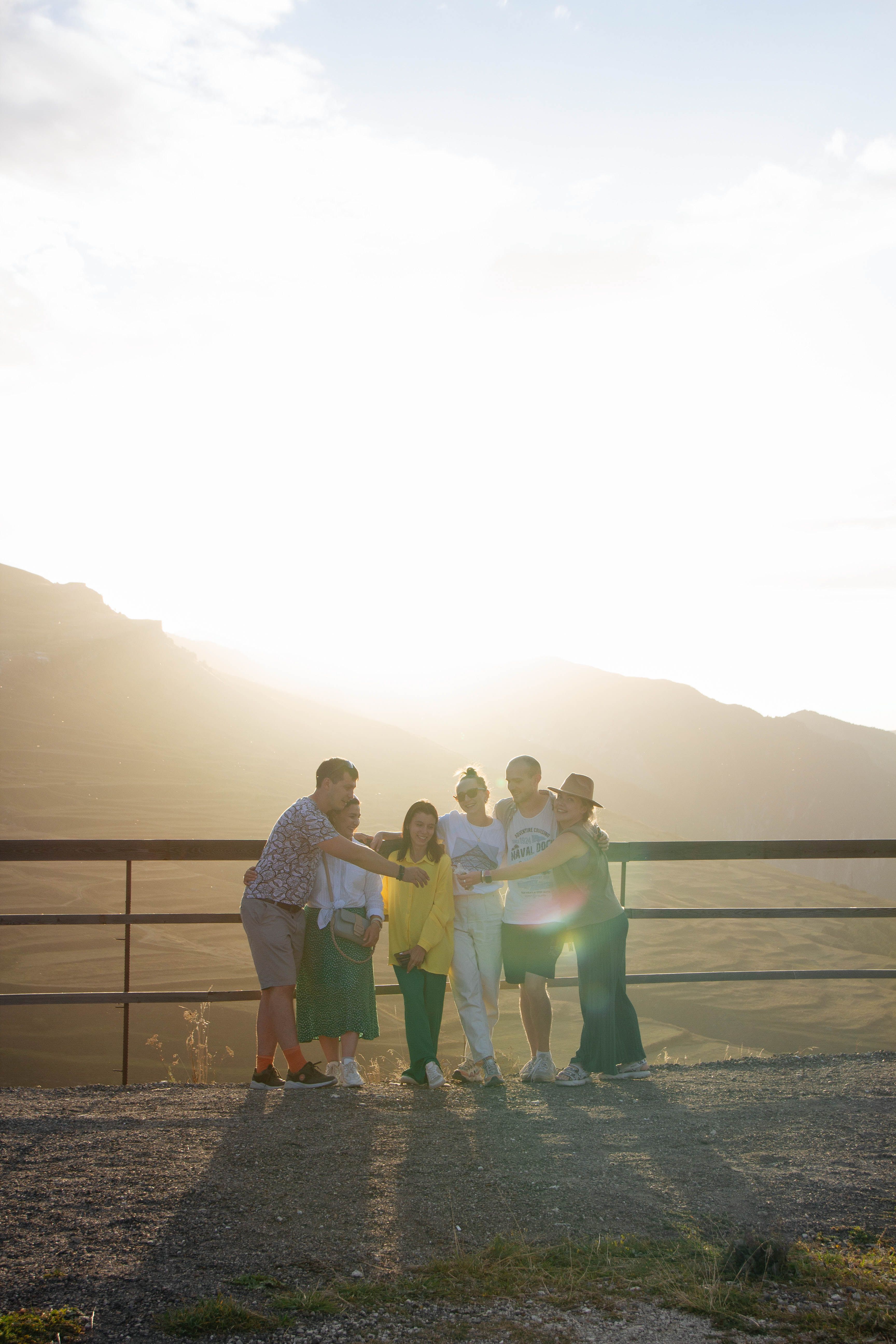 A Group of People Standing Together at Sunset · Free Stock Photo