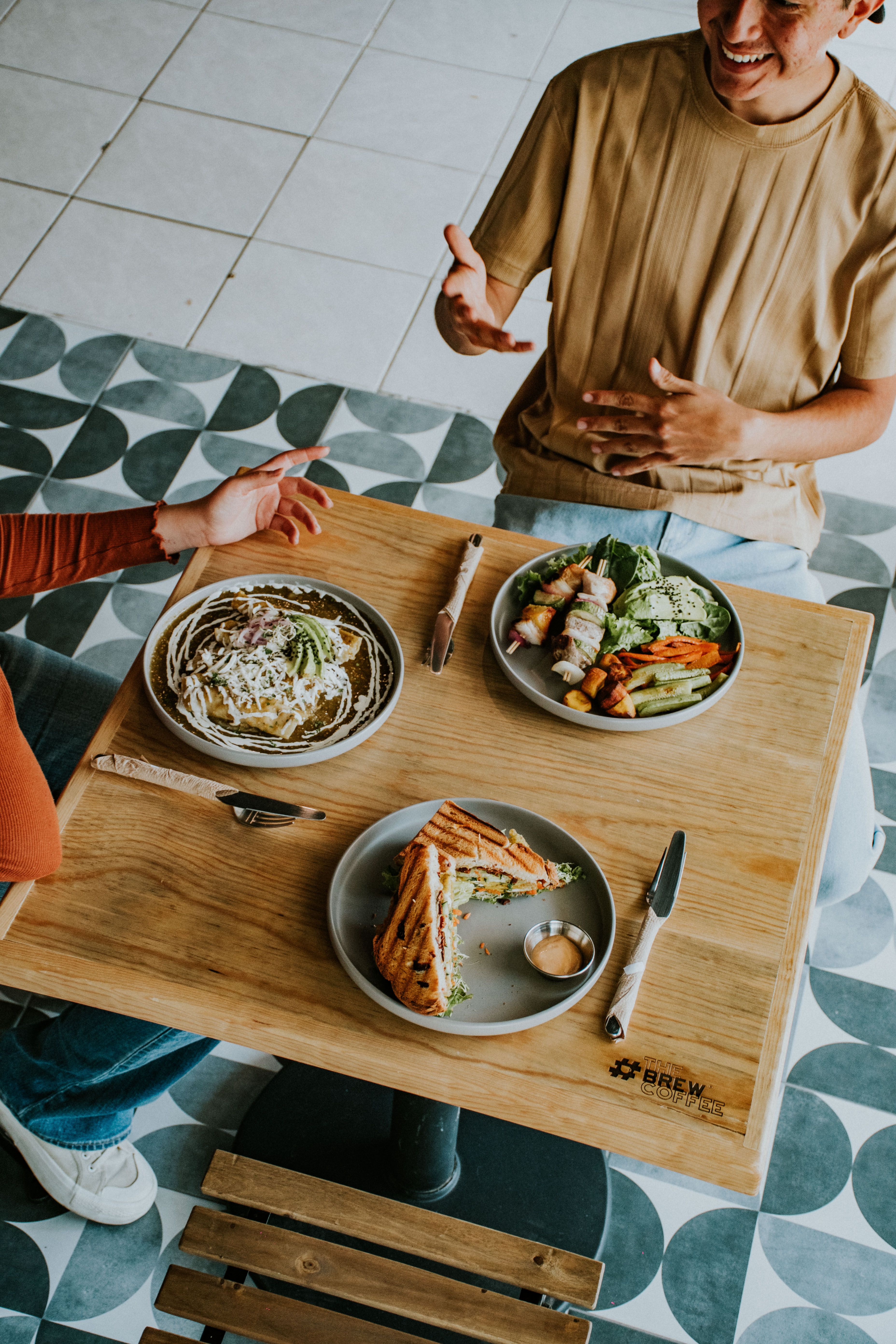 Smiling Man by Table with Food · Free Stock Photo