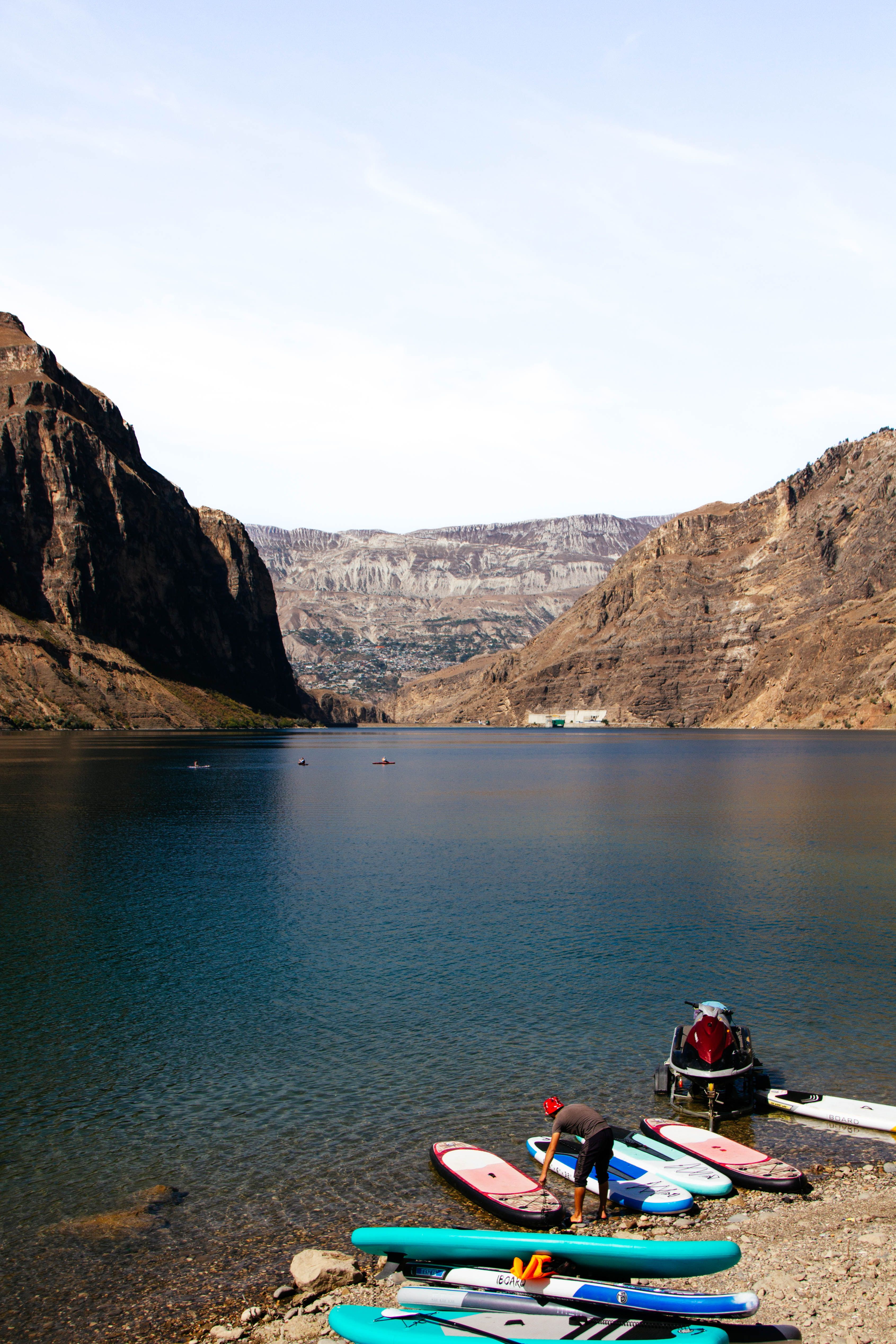 Surfboards and Jet Ski on the Shore of the Lake · Free Stock Photo