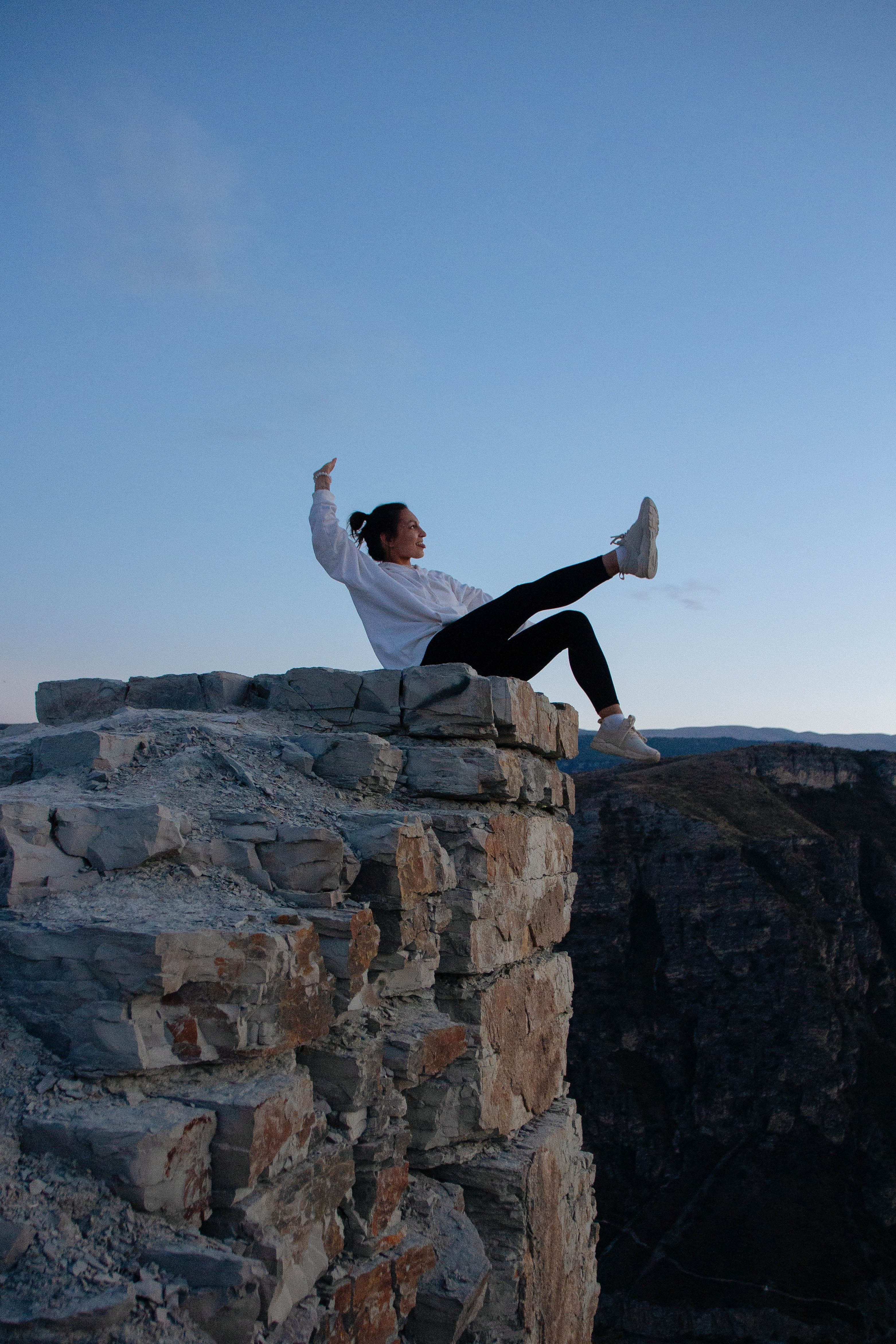 Side View of a Girl Balancing on a Stone Wall · Free Stock Photo