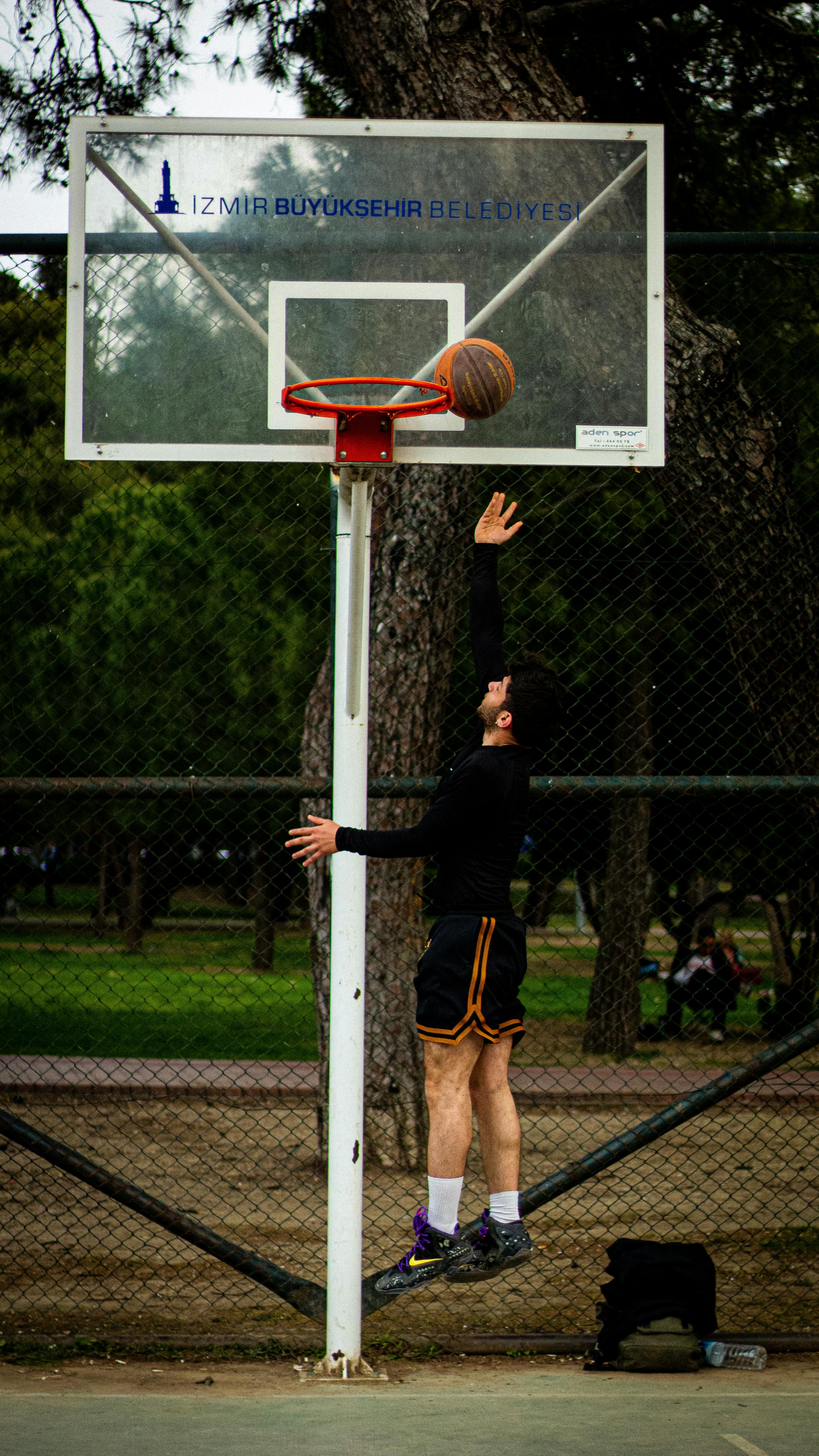 Basketball Player Jumping High for Accurate Throw · Free Stock Photo