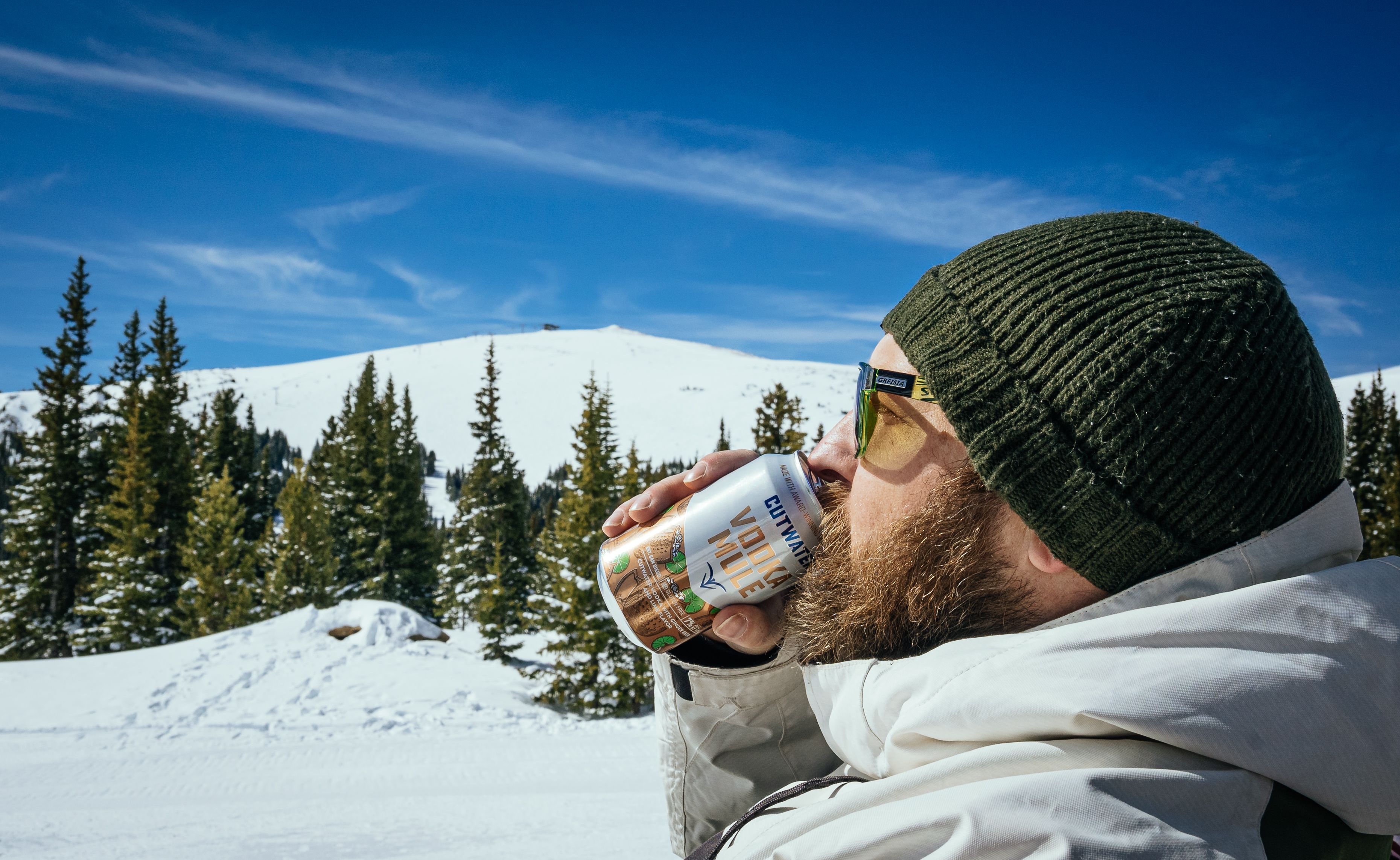 Man Drinking Vodka from Can near Trees in Winter · Free Stock Photo