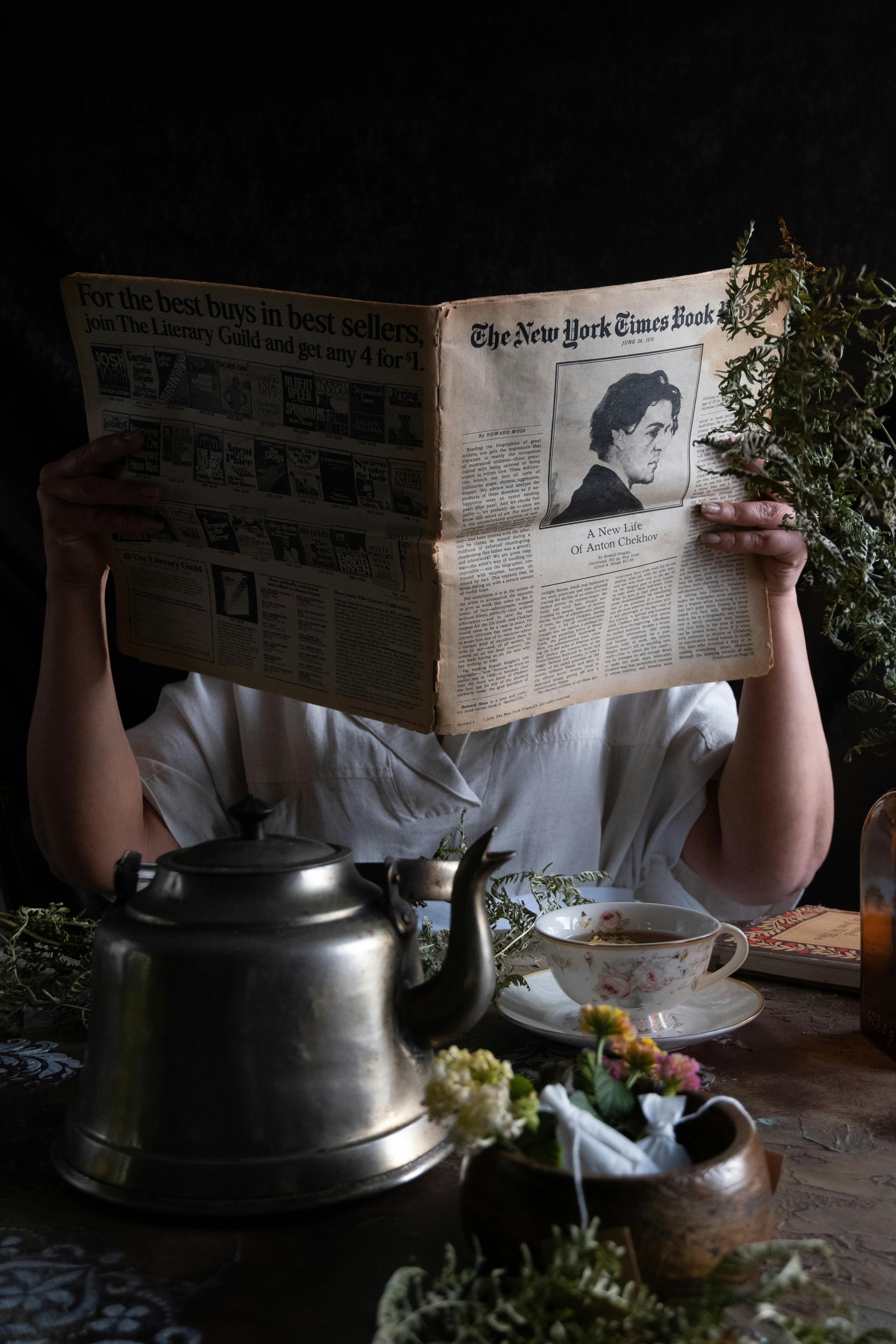 Person Holding and Reading Newspaper · Free Stock Photo