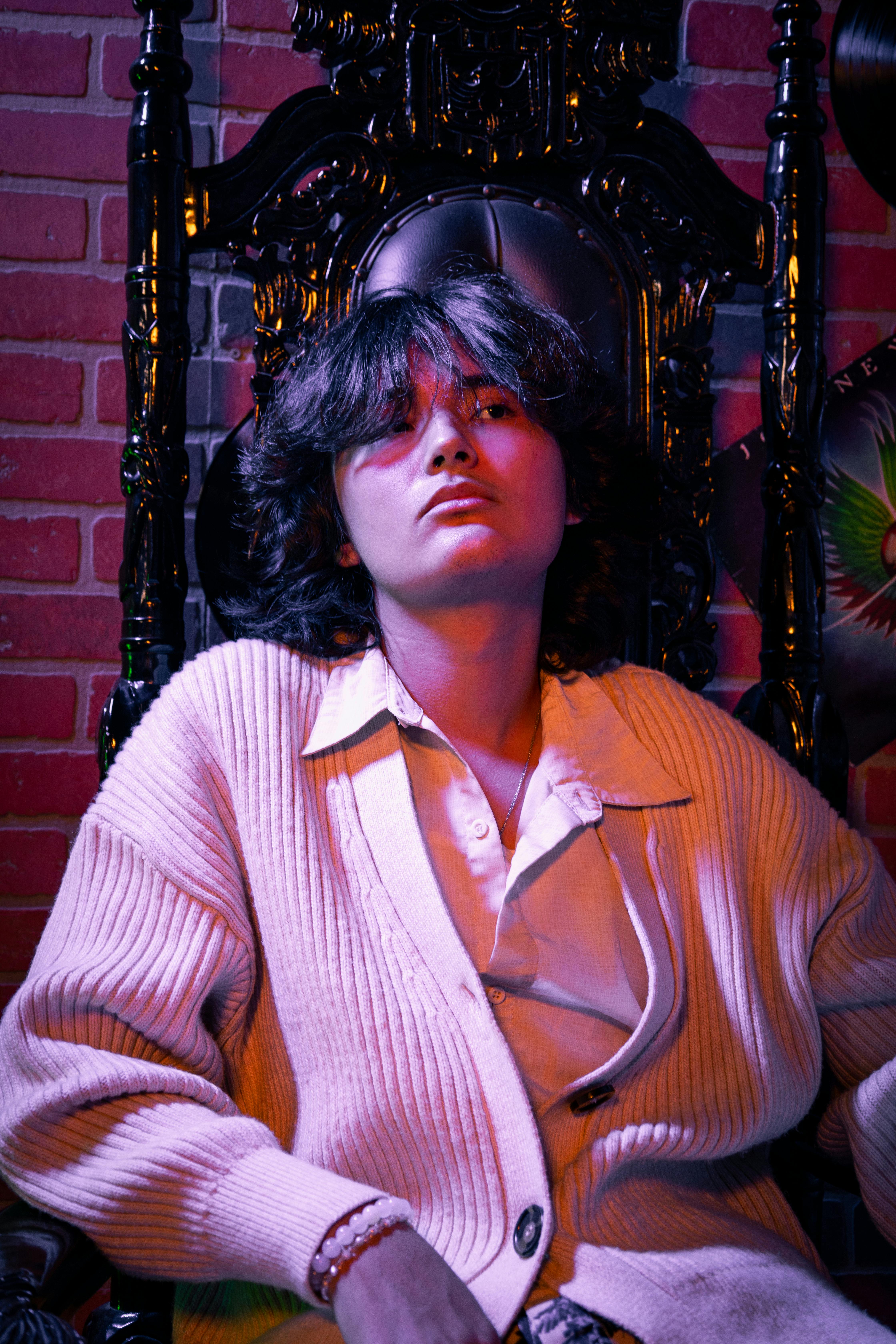 A woman sitting on a chair with her head down · Free Stock Photo