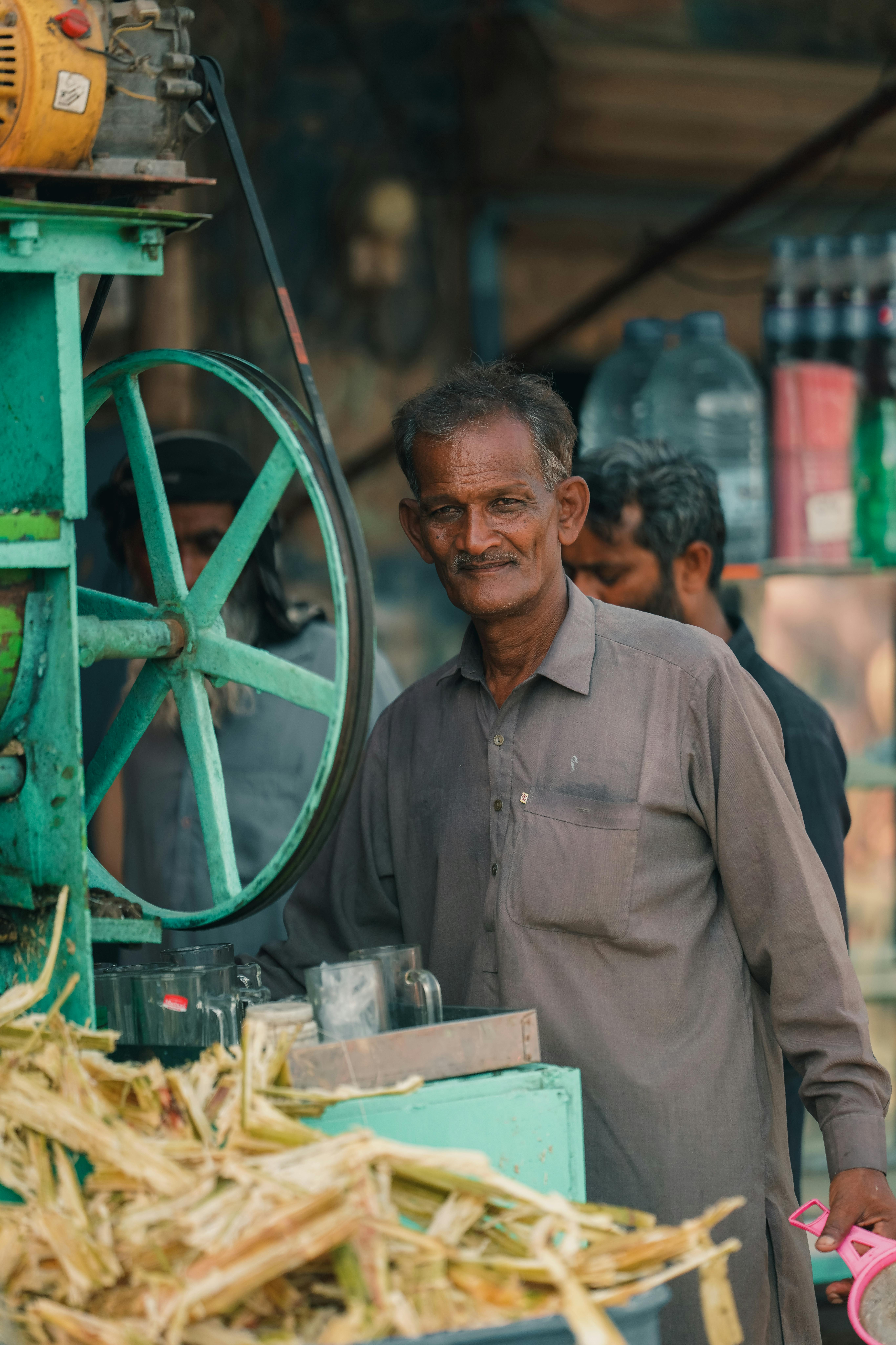 Elderly Man Standing Standing next to a Machine Producing Sugarcane ...