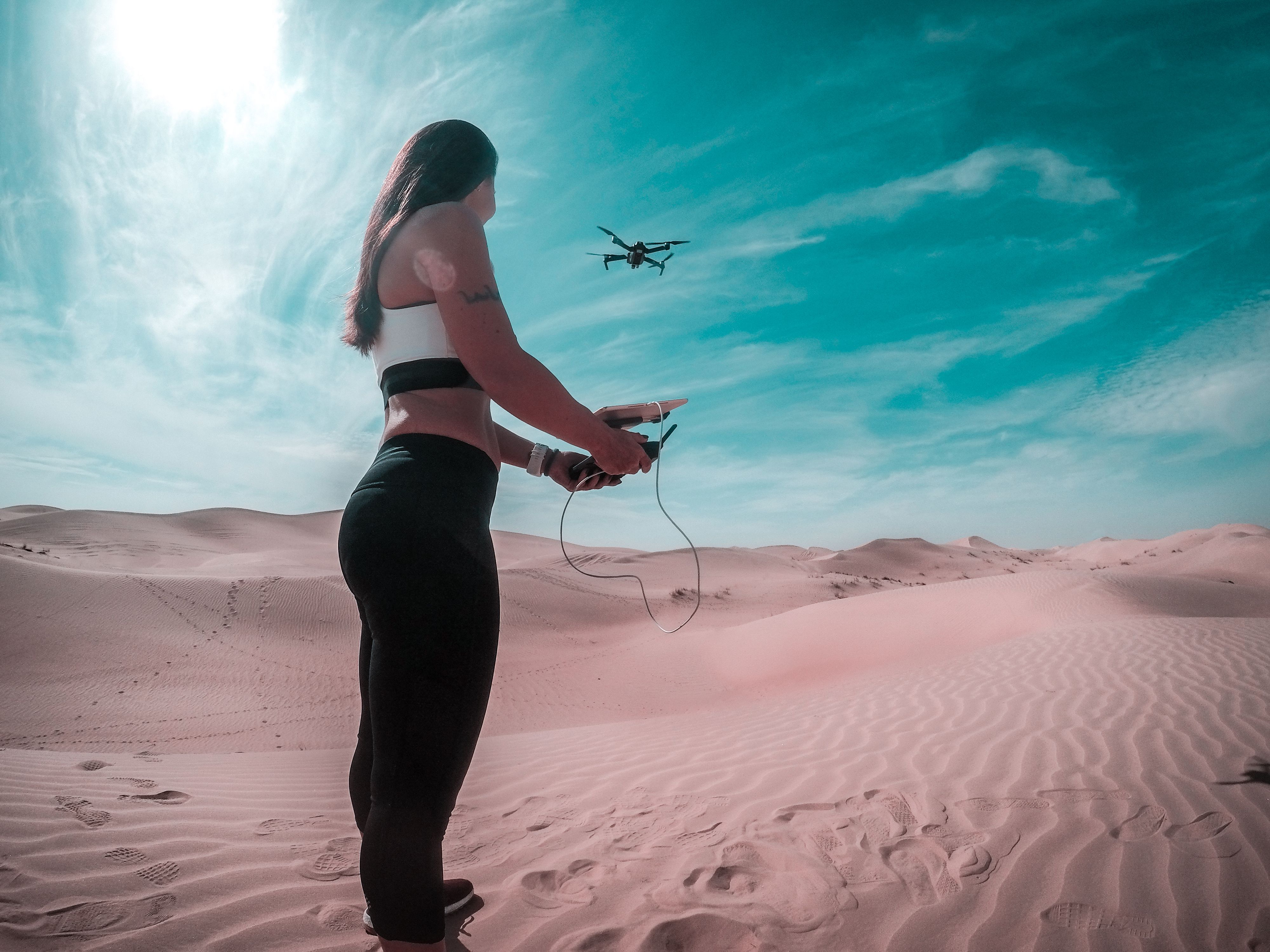 Drone on Mid Air While Woman Holding Controller · Free Stock Photo