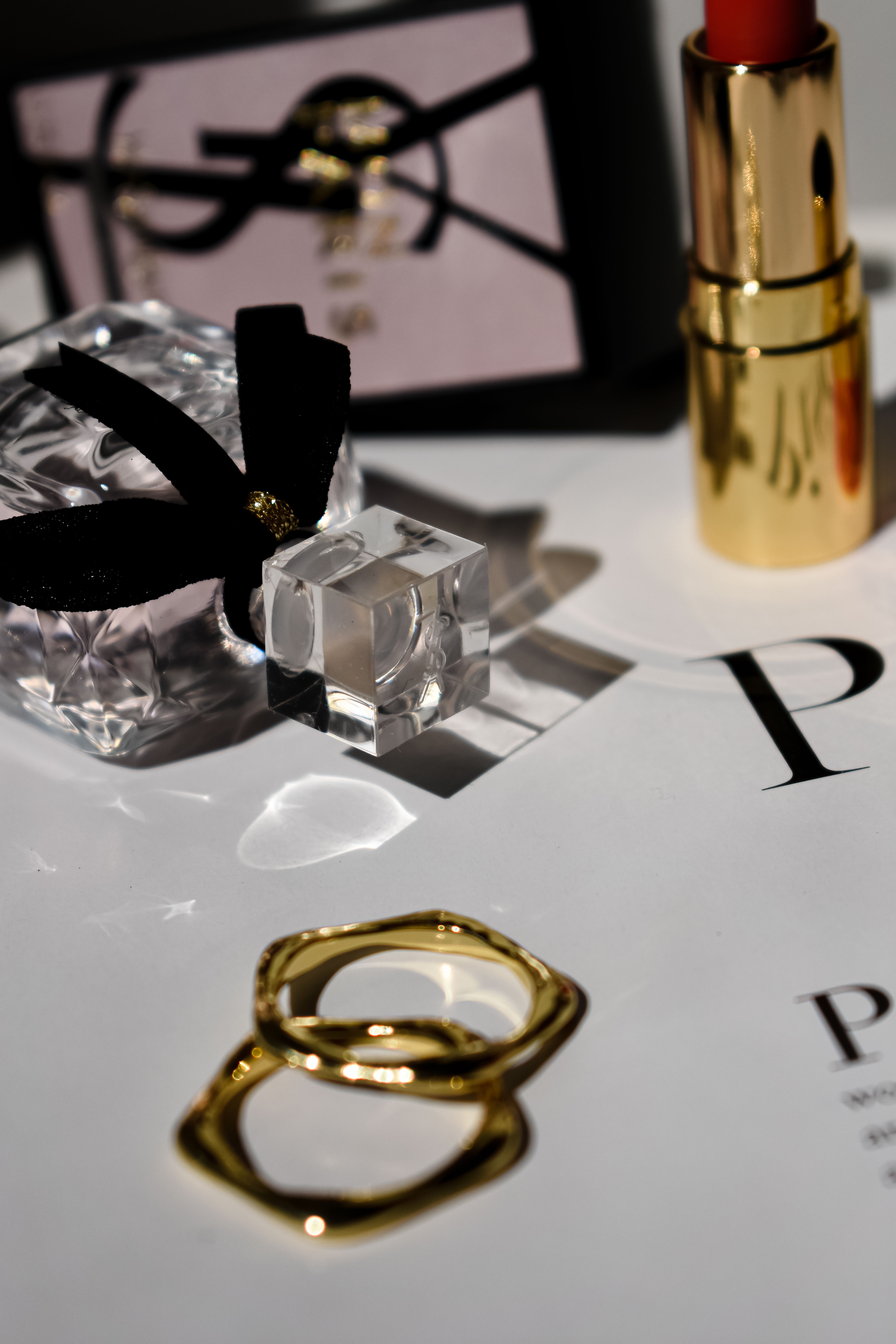 Perfume Vial with Ribbon and near Rings · Free Stock Photo