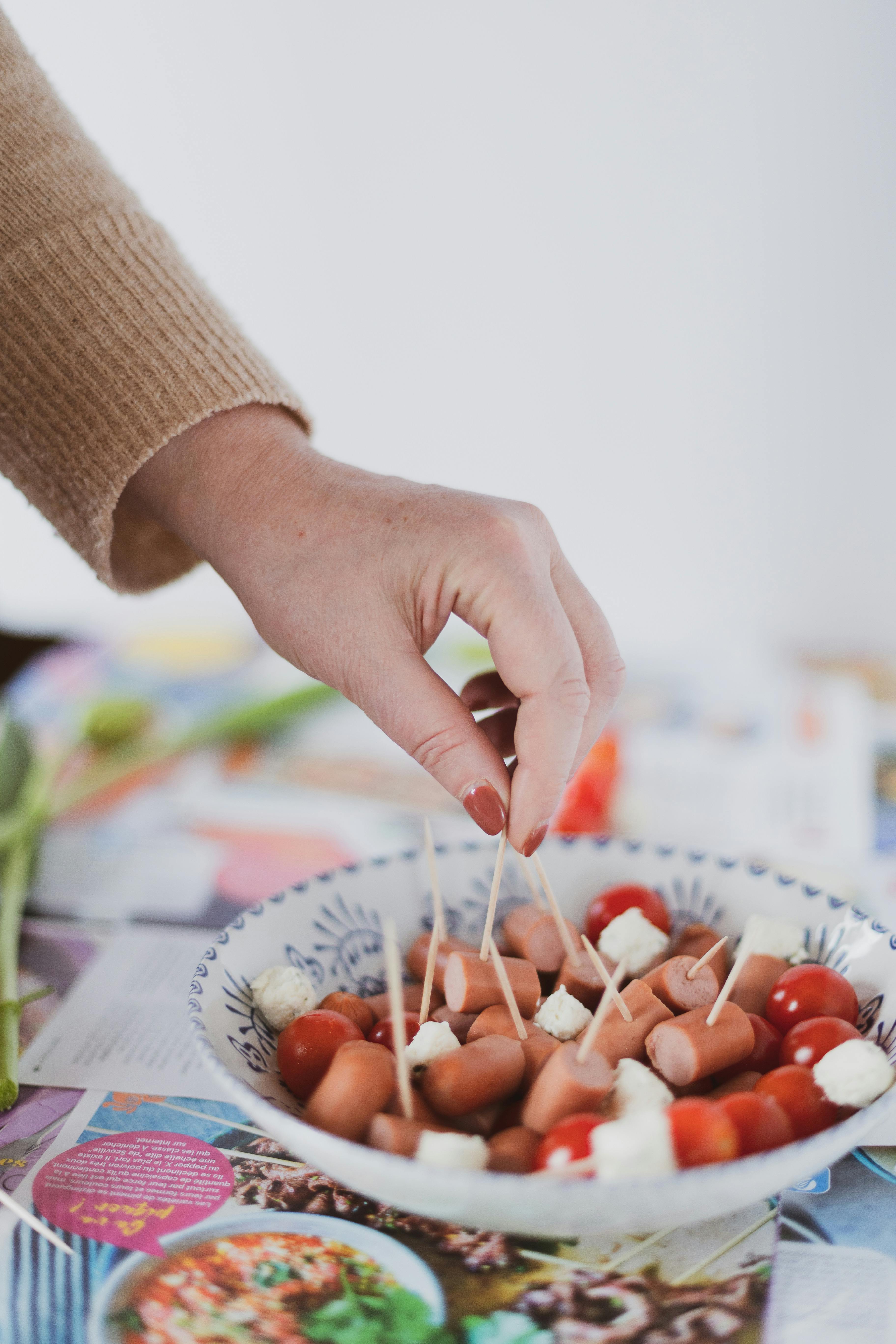 A Hand Picking Finger Foods · Free Stock Photo