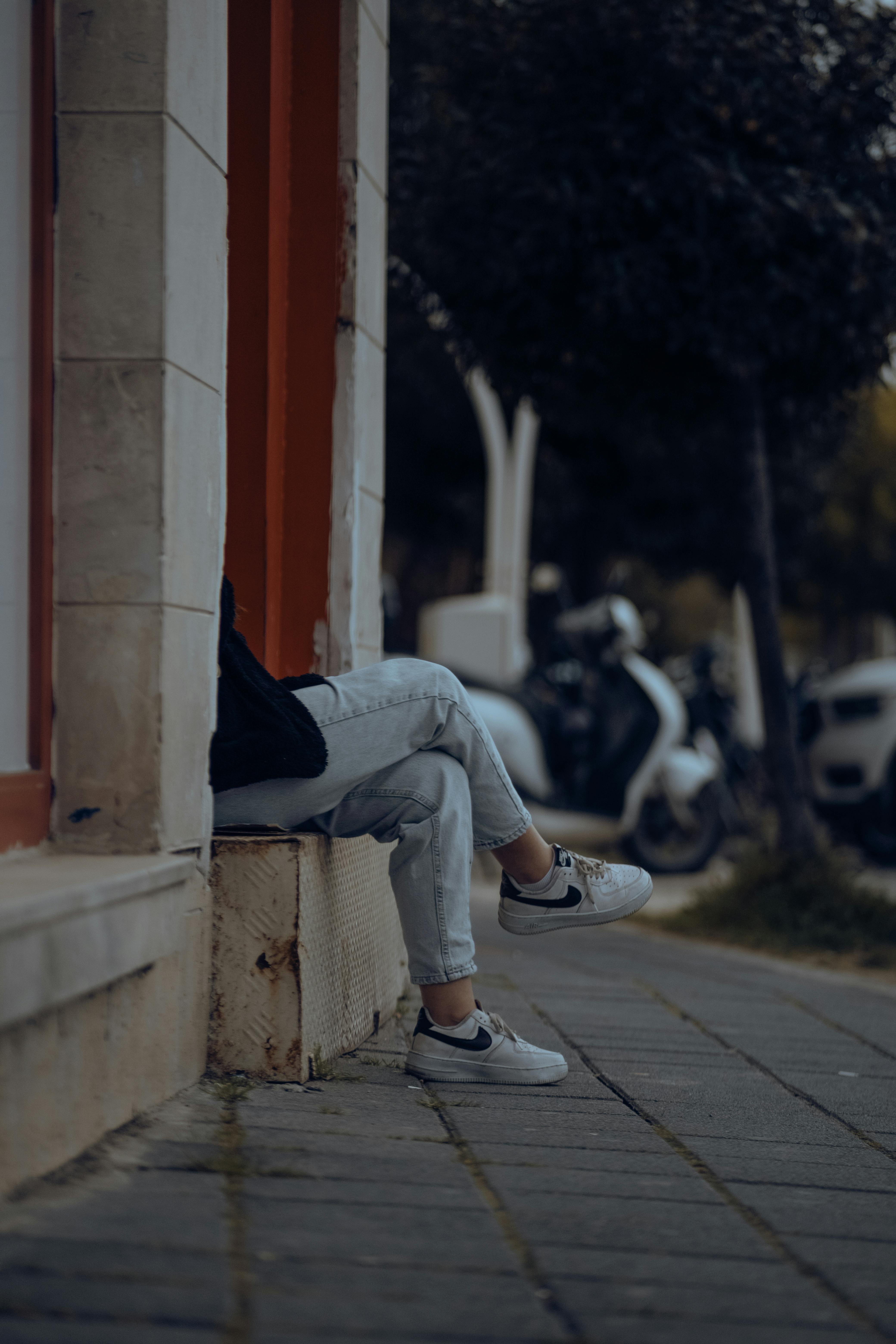 Man Sitting on Wall at Park · Free Stock Photo