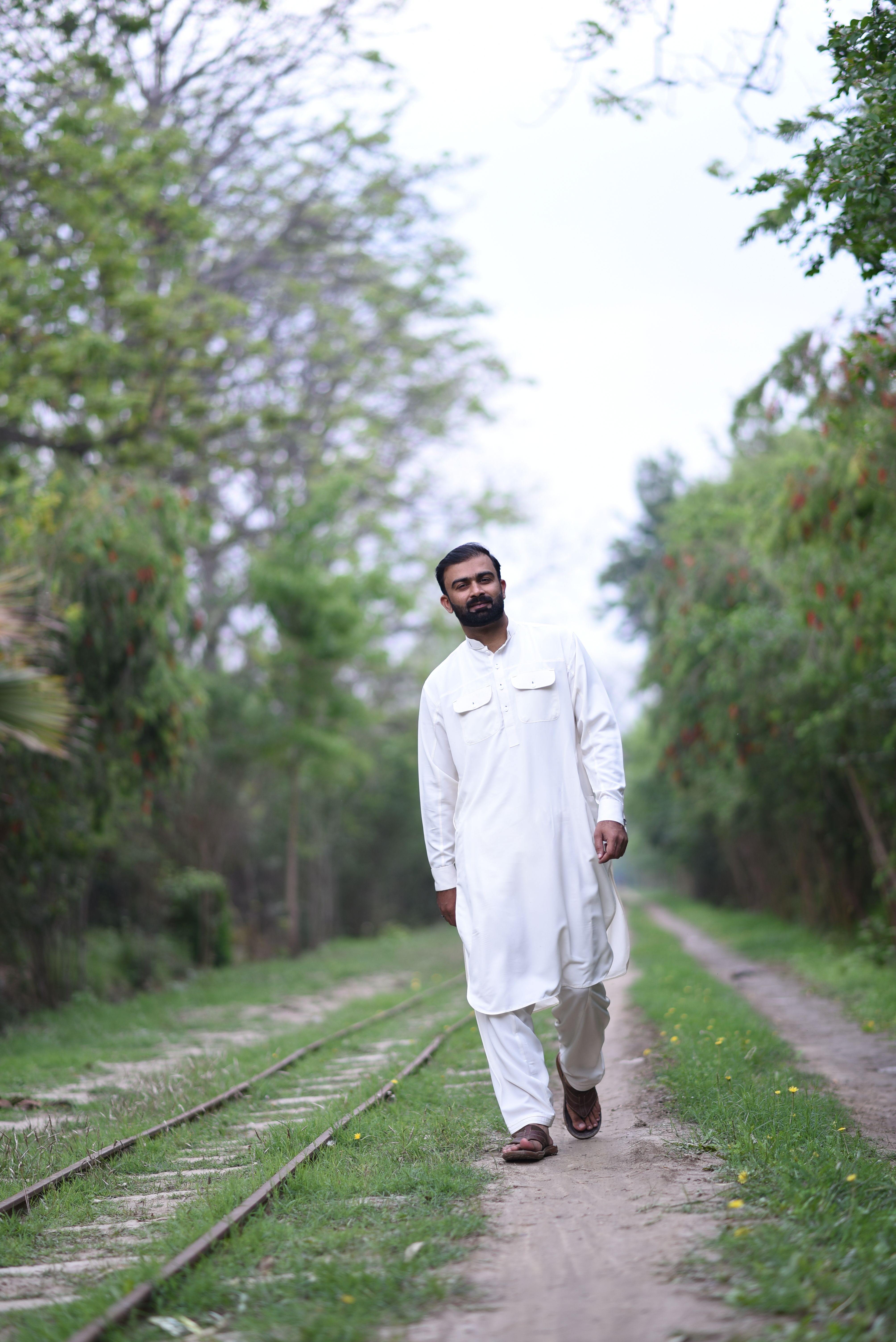 Man in Traditional Clothing Walking on Footpath near Railway · Free ...