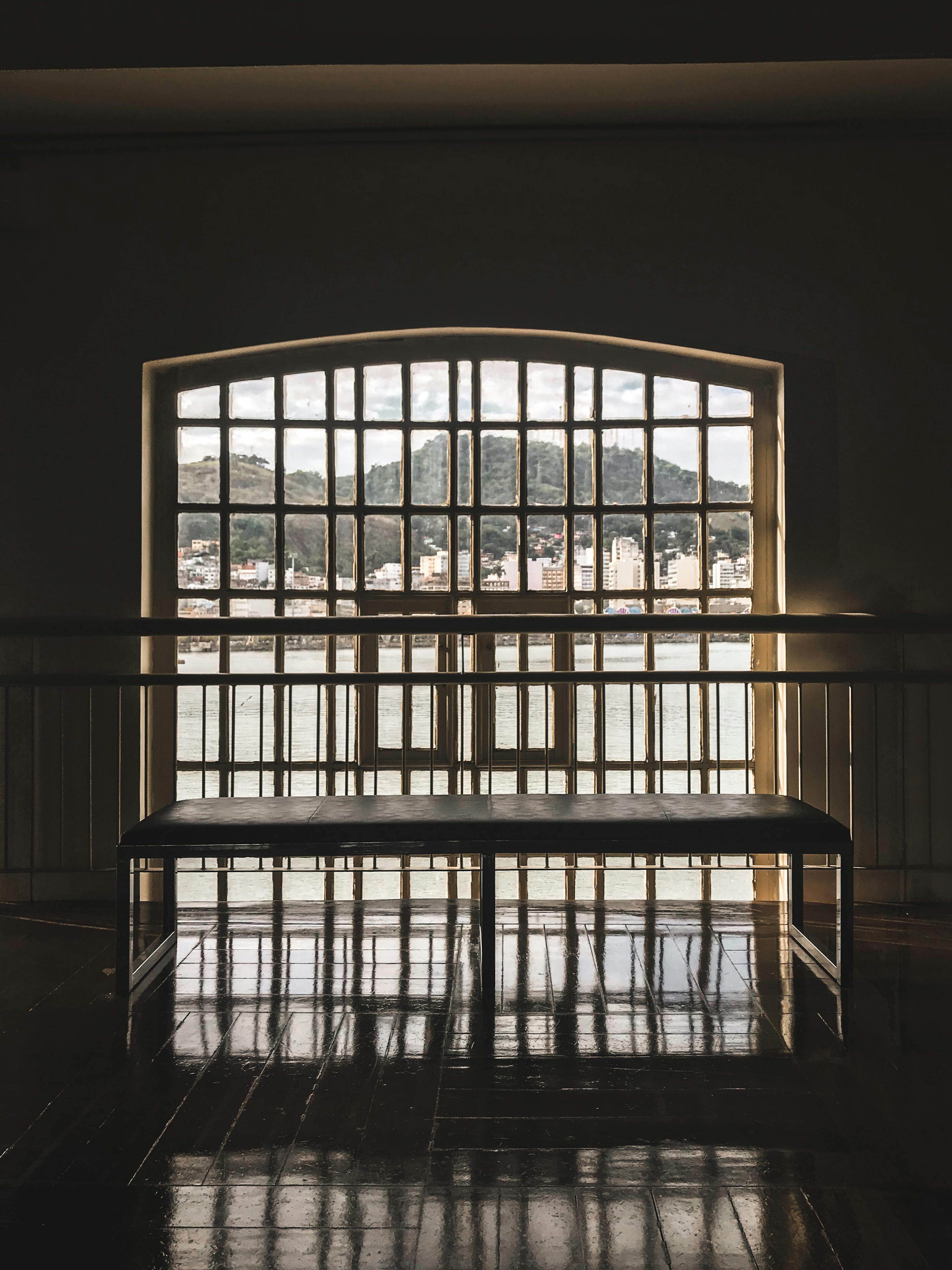 Empty Building Interior with Bars in the Window · Free Stock Photo