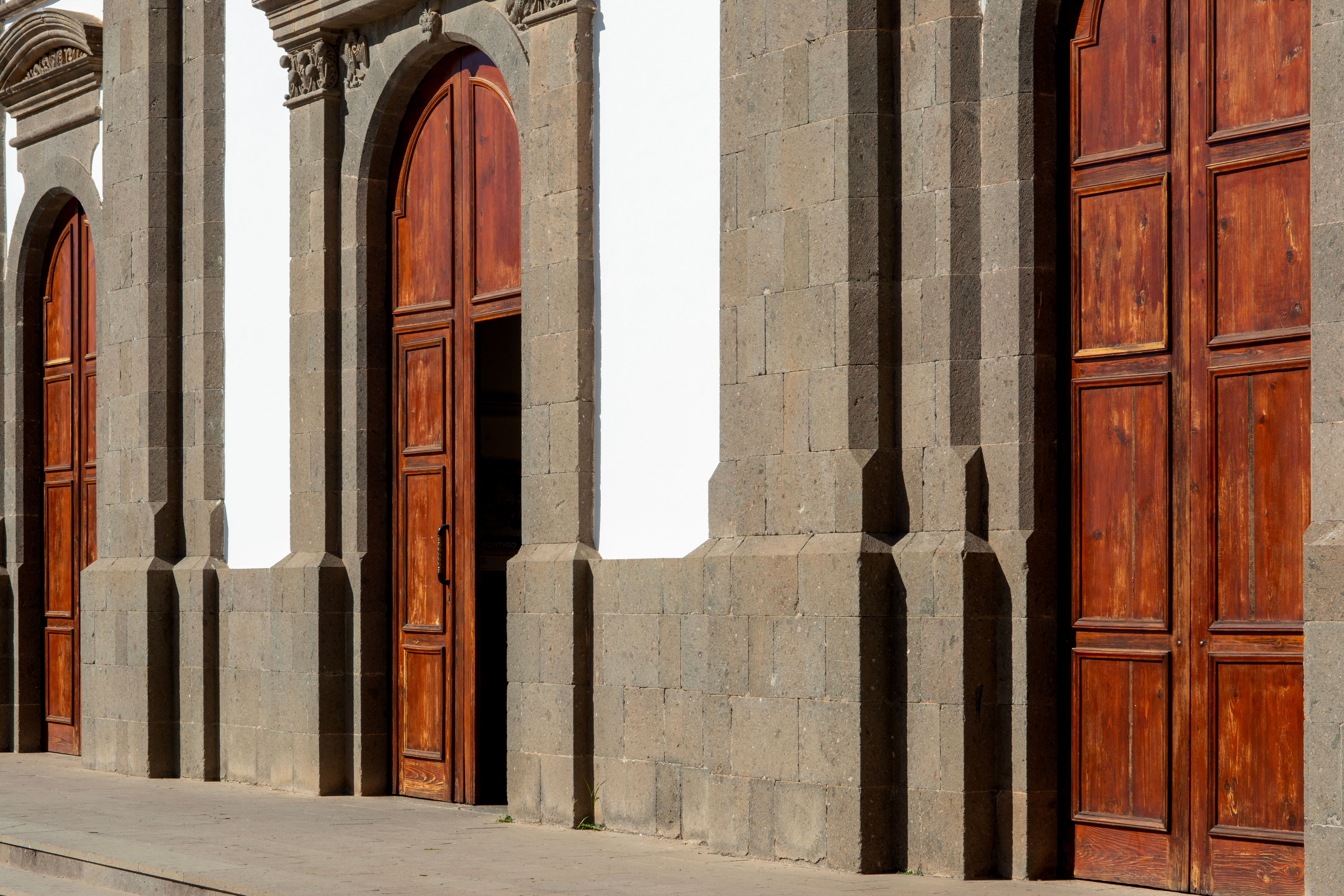 A row of wooden doors on a building · Free Stock Photo