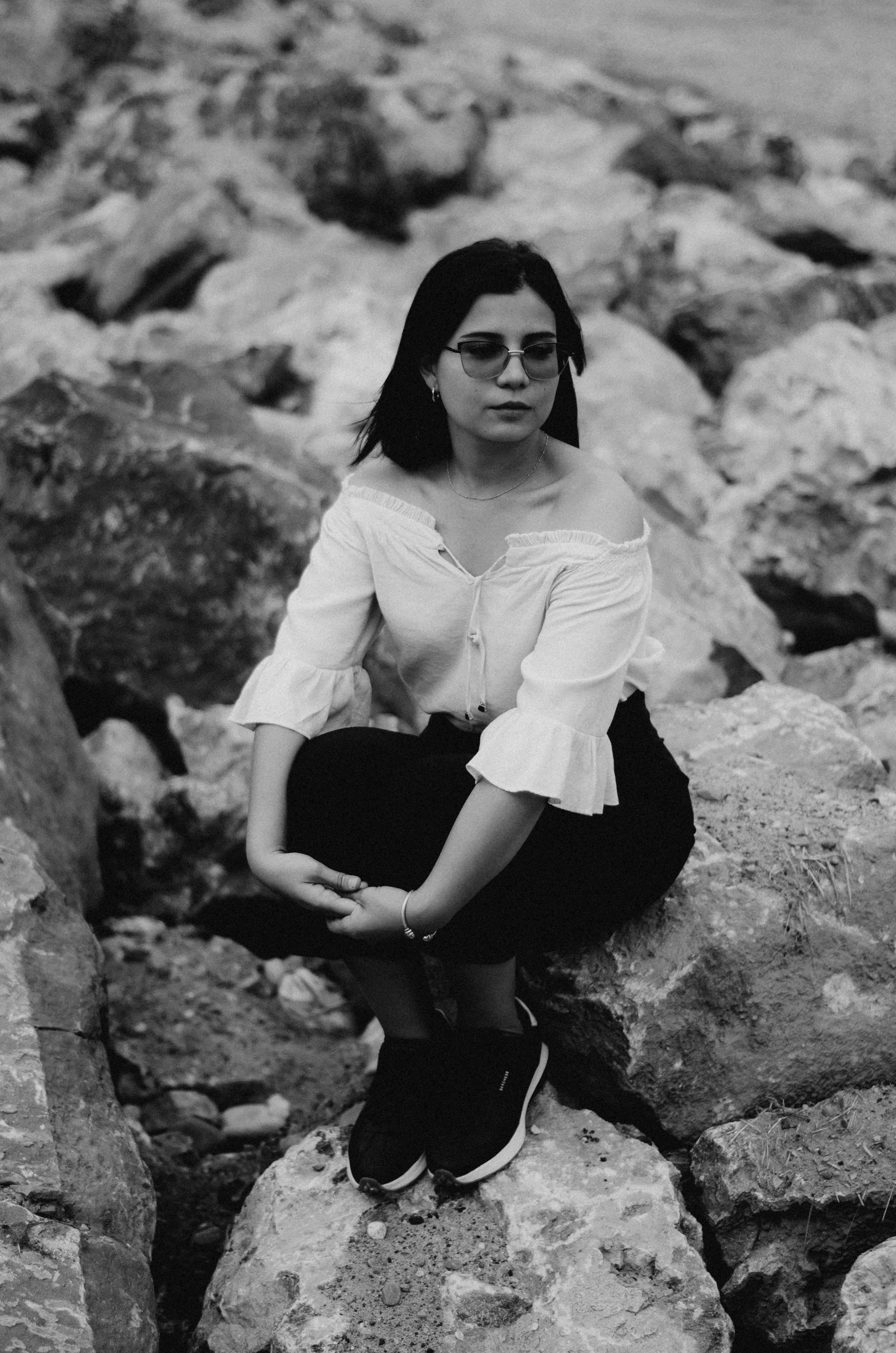 Woman Sitting on Stones and Posing · Free Stock Photo
