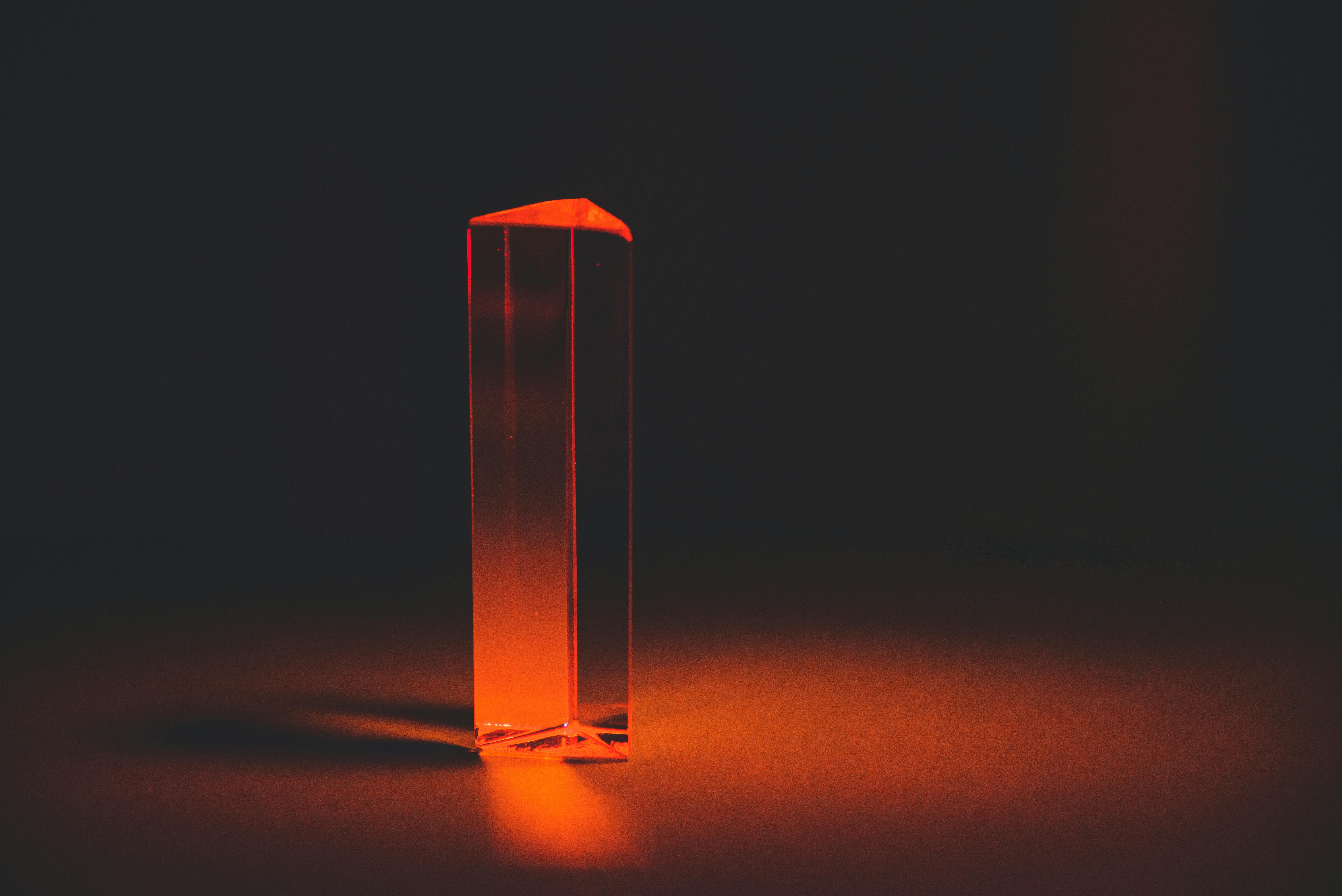 Red Light on Transparent Geometric Shape in Dark · Free Stock Photo