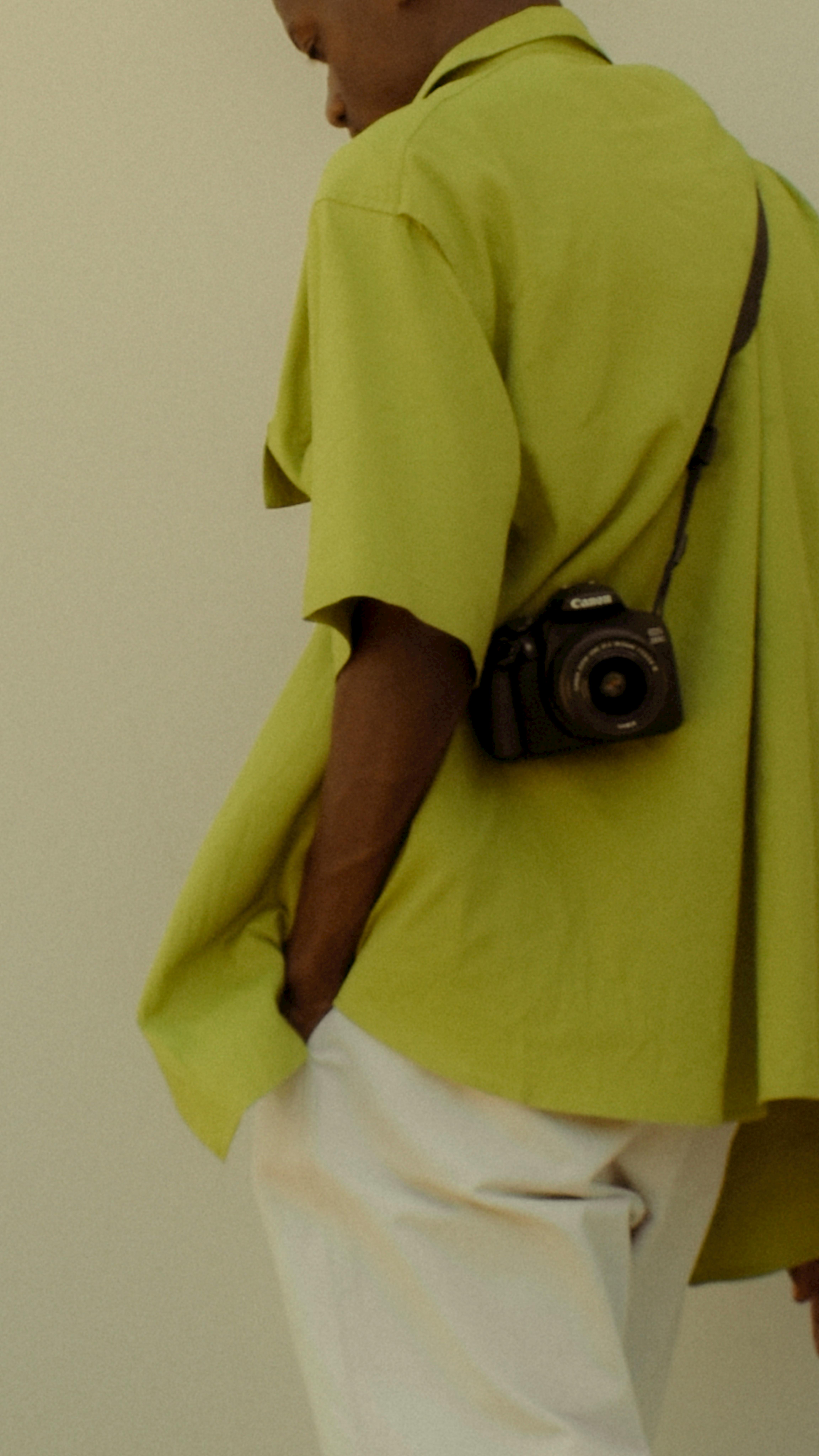 Man in a Shirt Carrying a Camera across His Shoulder · Free Stock Photo