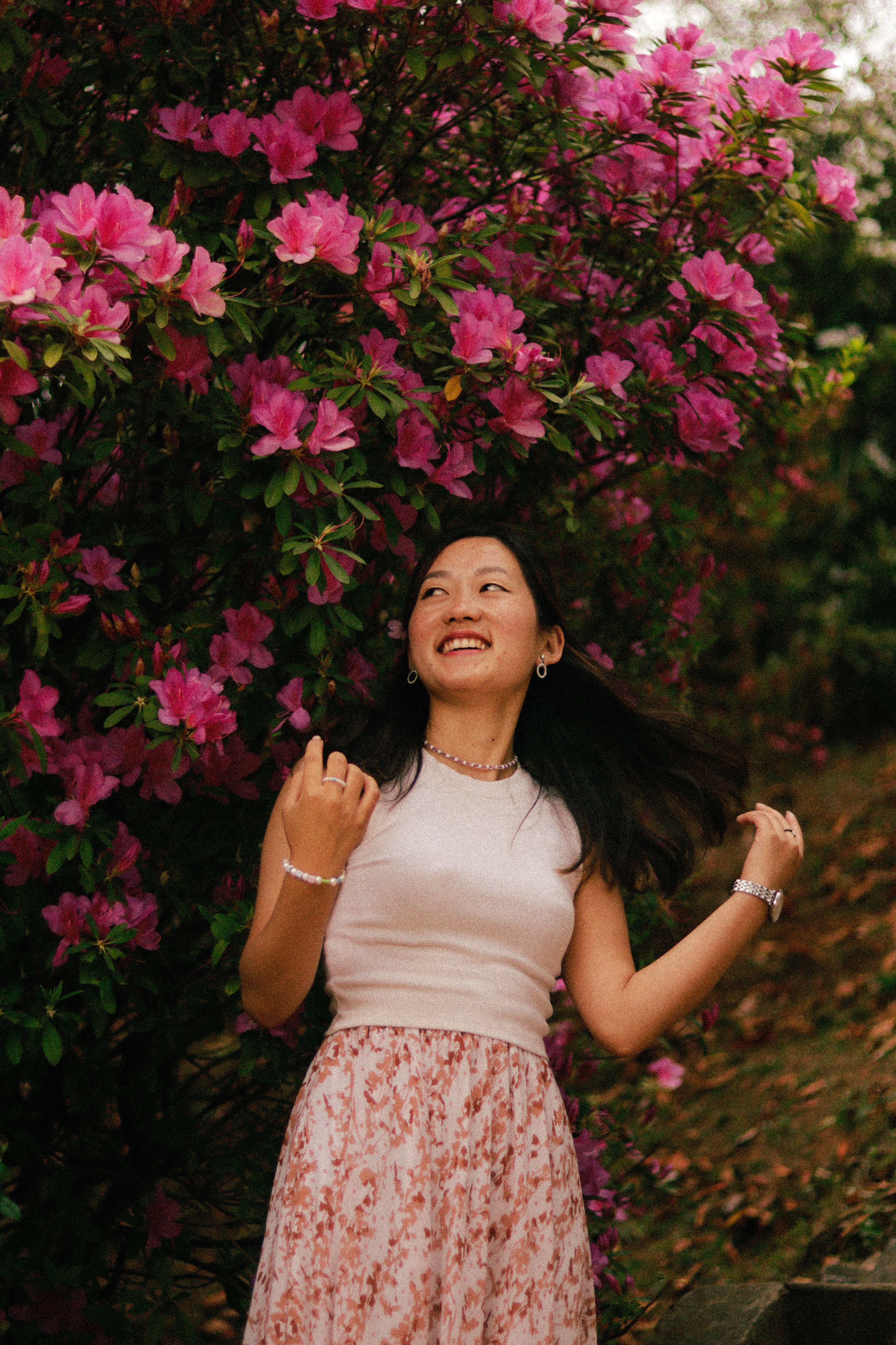 Woman Standing Against Flowers · Free Stock Photo