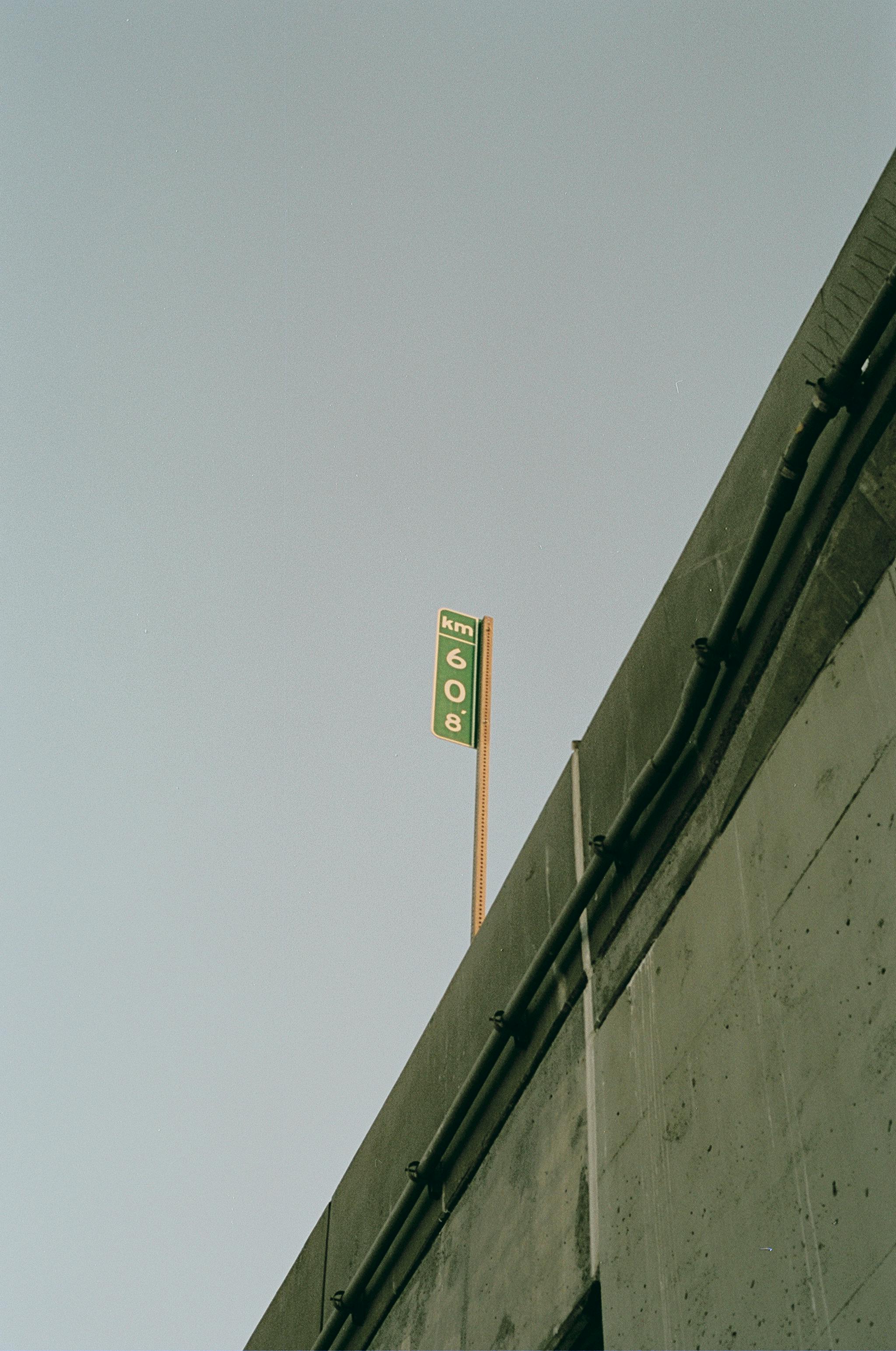 Milestone Sign on the Highway Wall · Free Stock Photo
