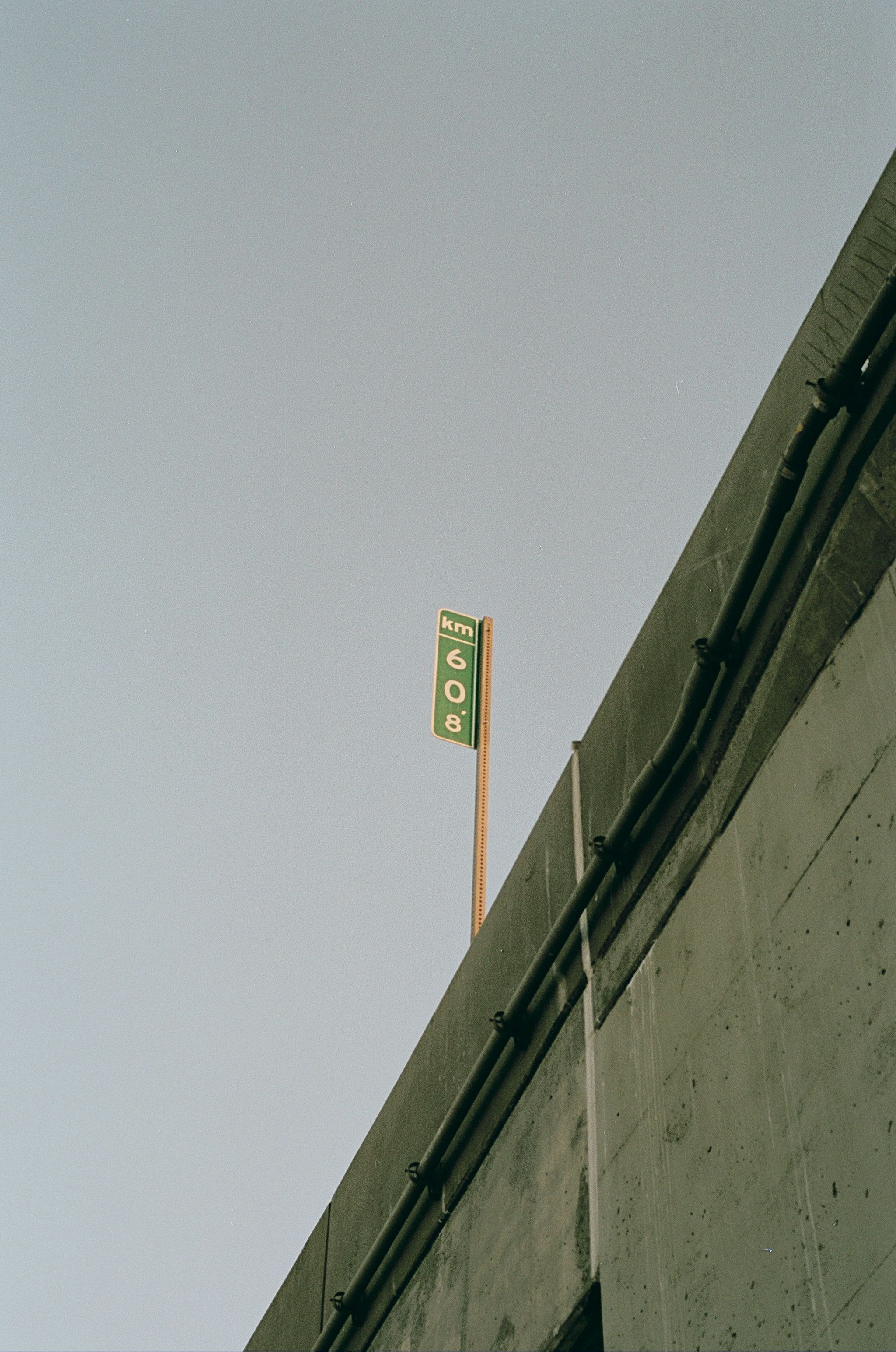 Milestone Sign on the Highway Wall · Free Stock Photo