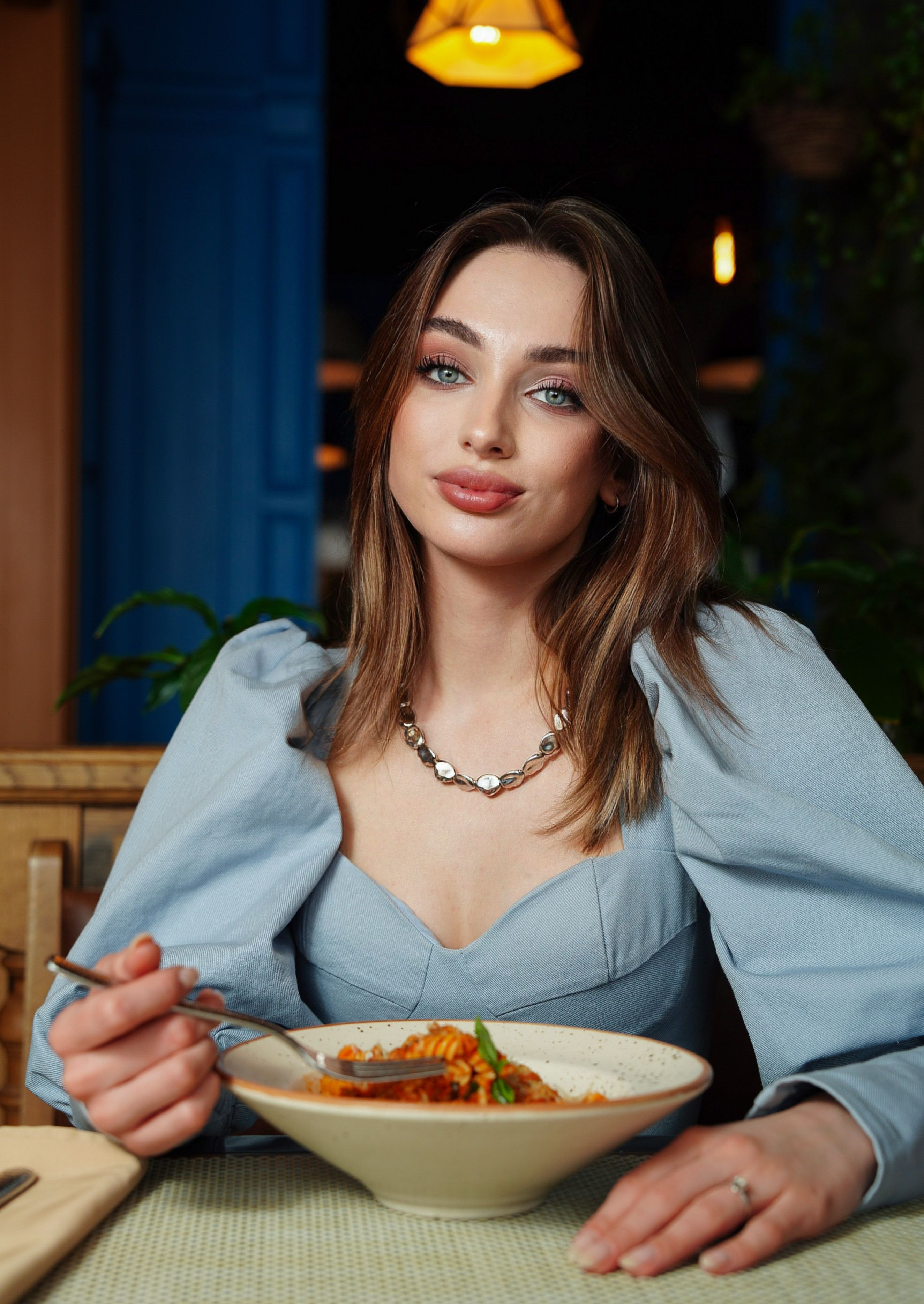 Elegant Brunette Woman Eating Lunch in Restaurant · Free Stock Photo