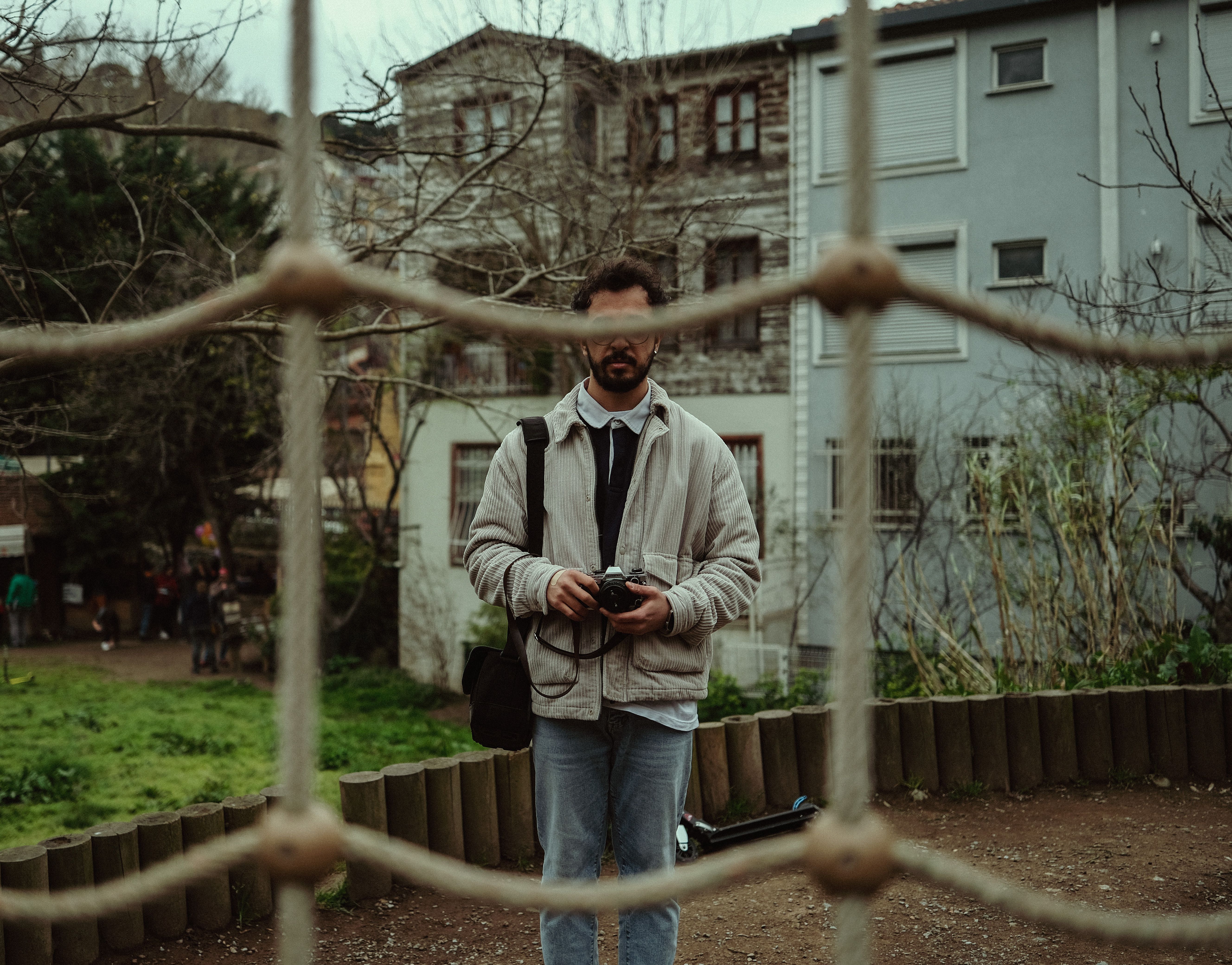 Man Standing behind the Net · Free Stock Photo