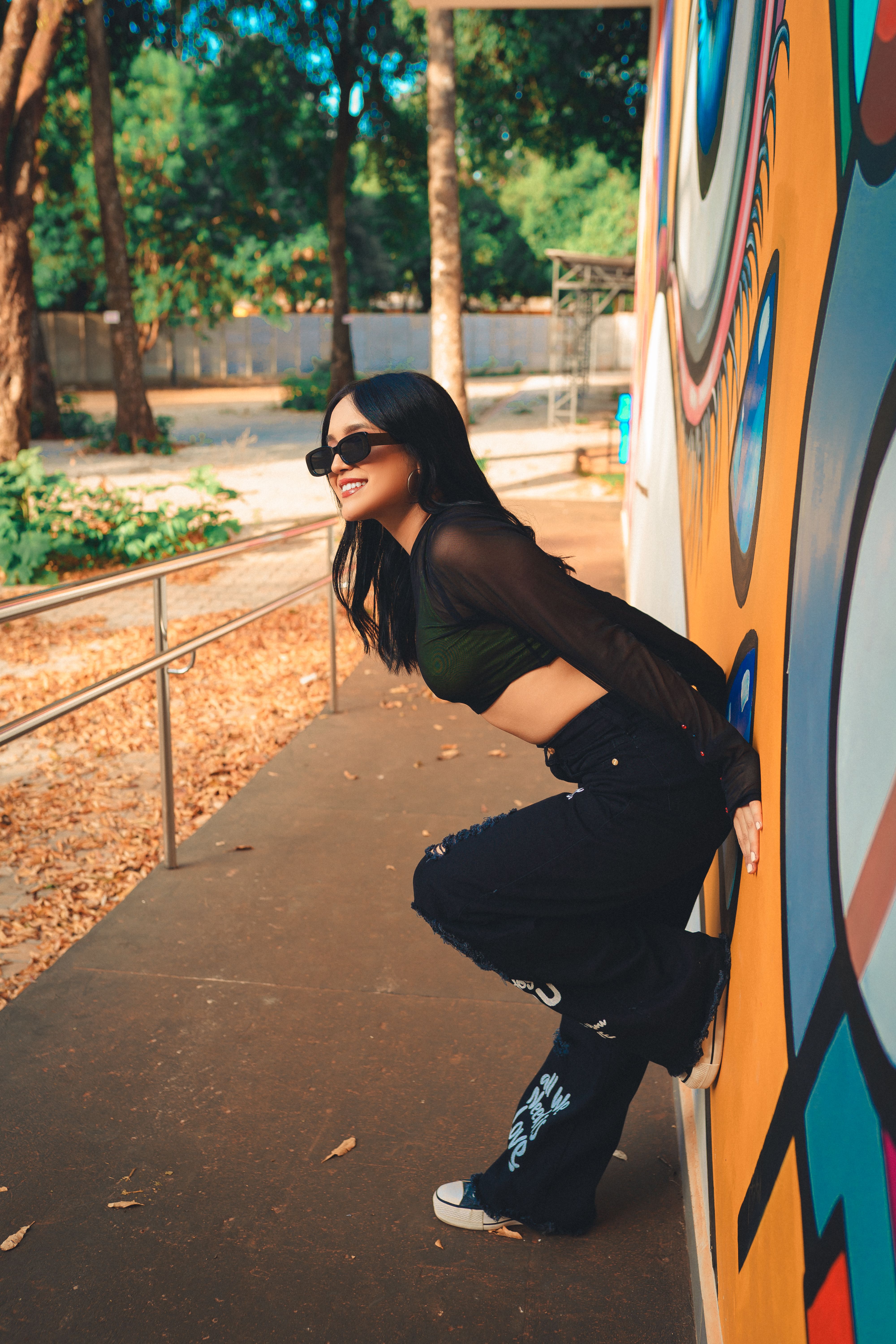 Young Woman Posing next to a Graffiti Wall · Free Stock Photo