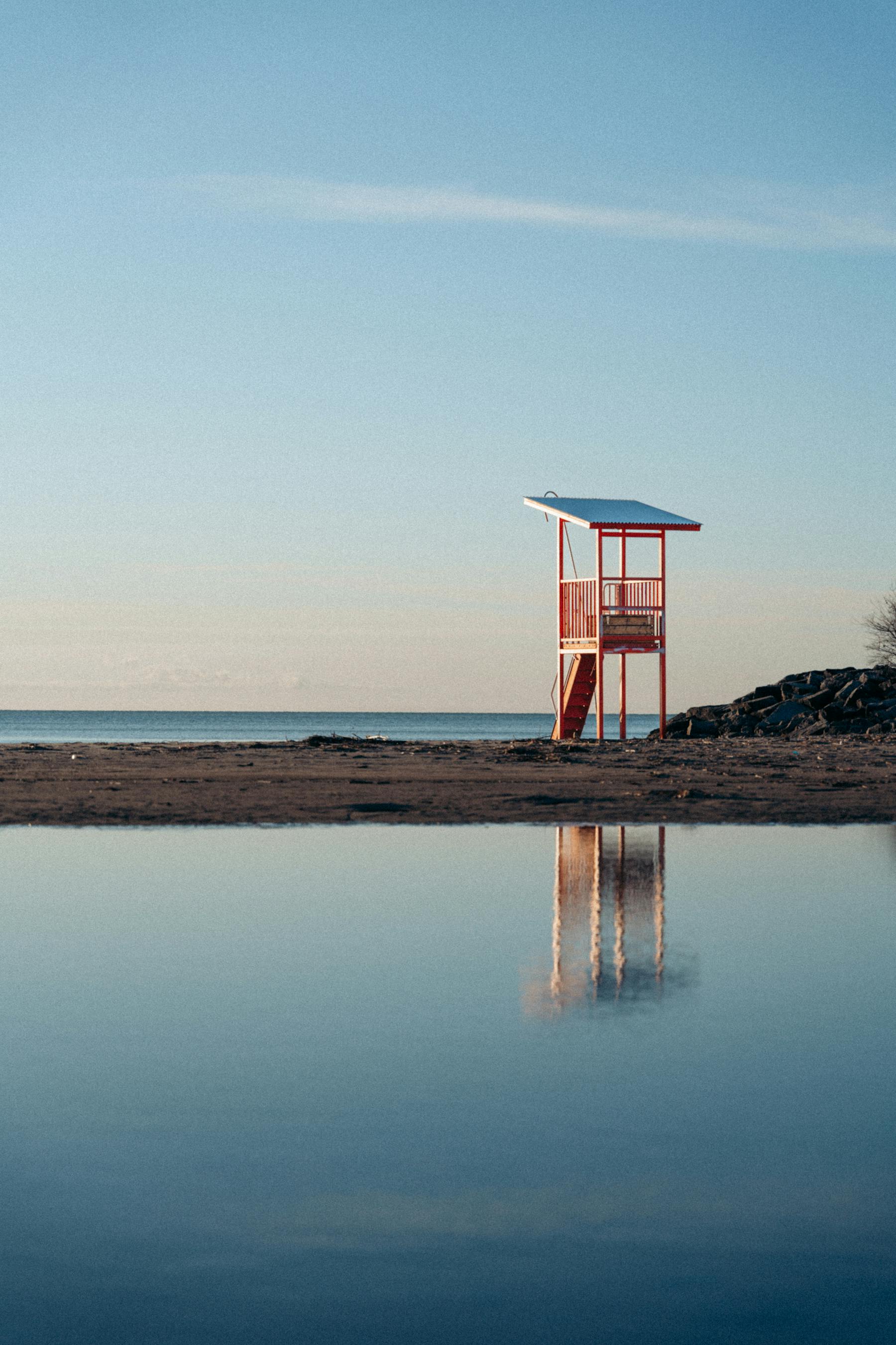 Water and Lifeguard Tower on Beach behind · Free Stock Photo