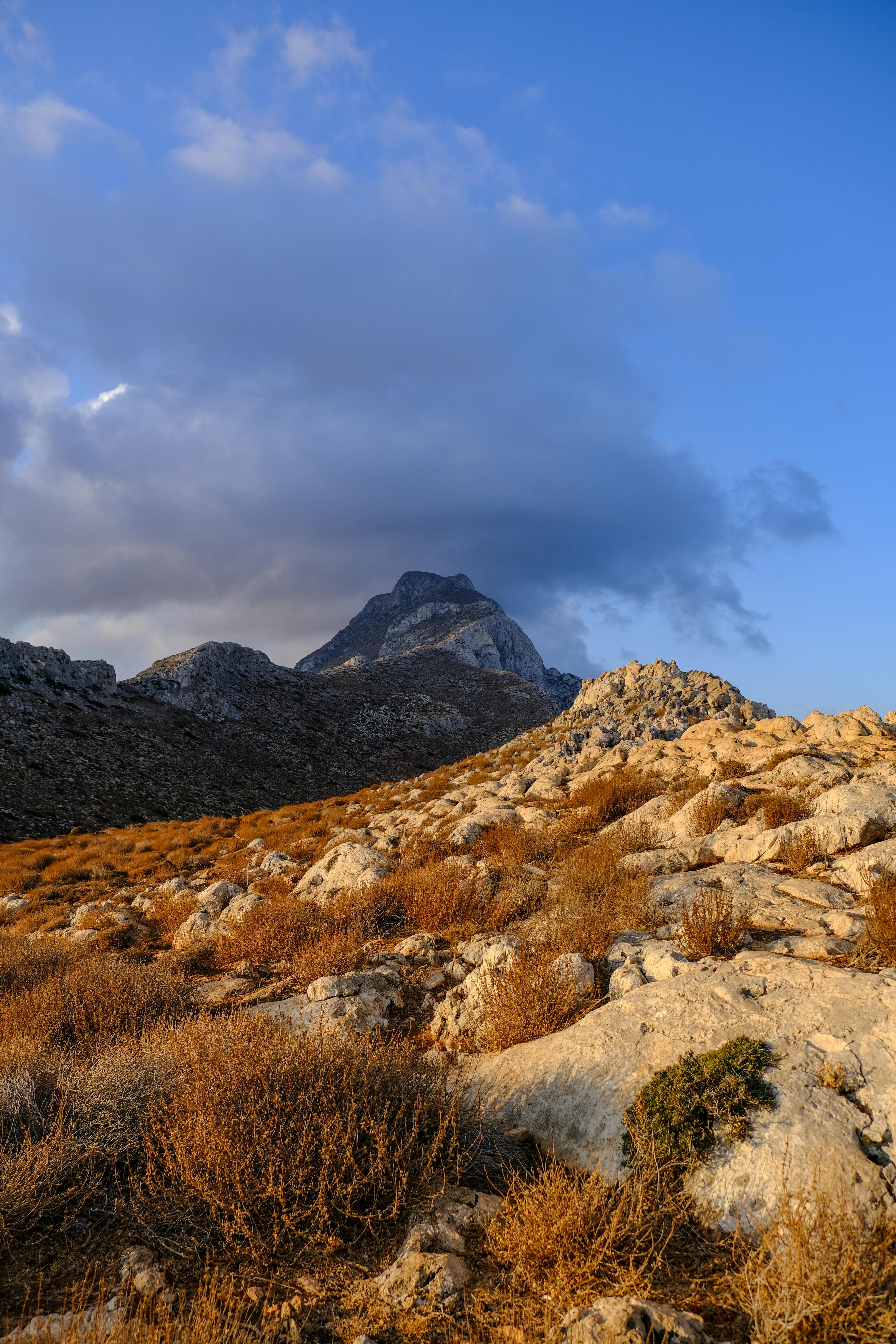 Arid Hill with Mountains behind · Free Stock Photo