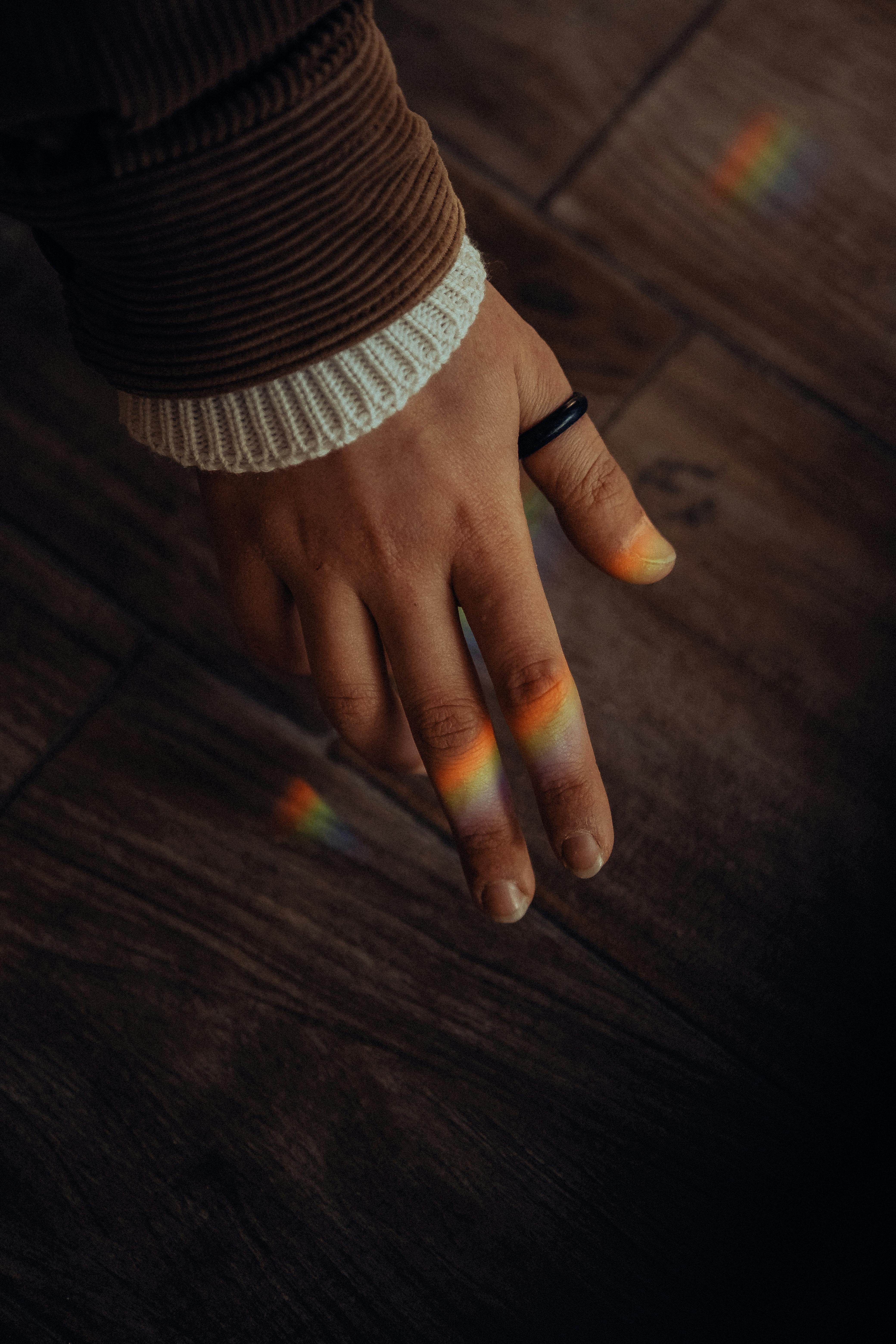 Blue and Orange Light Projeced on Left Hand of Person · Free Stock Photo