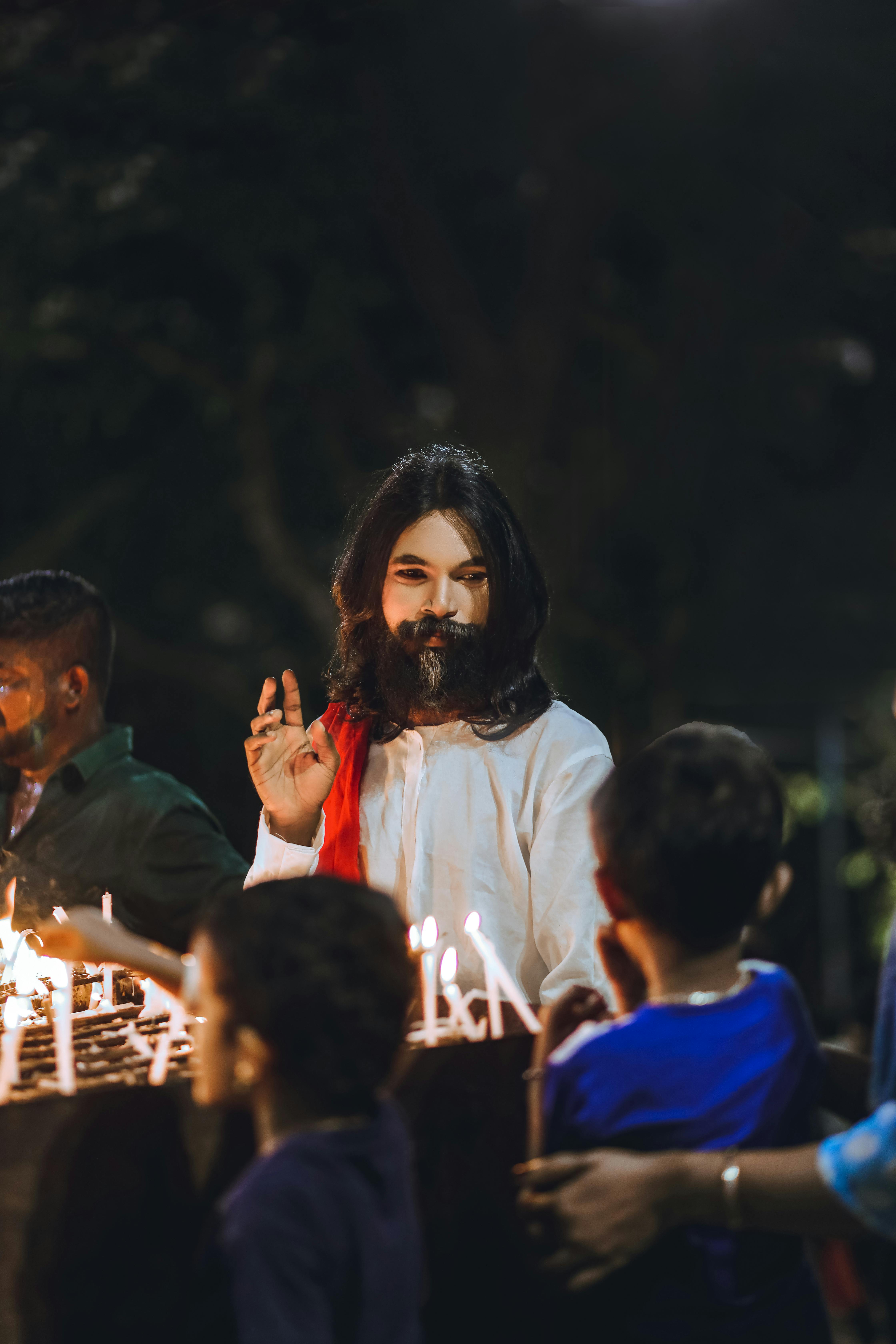 Person in Jesus Christ Costume Saluting to Children · Free Stock Photo